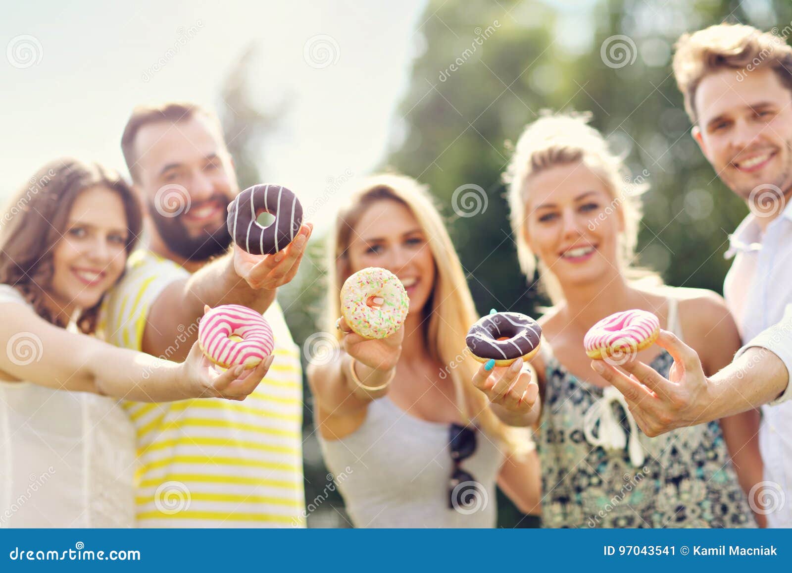 Group of Friends Eating Donuts Outdoors Stock Image - Image of summer ...
