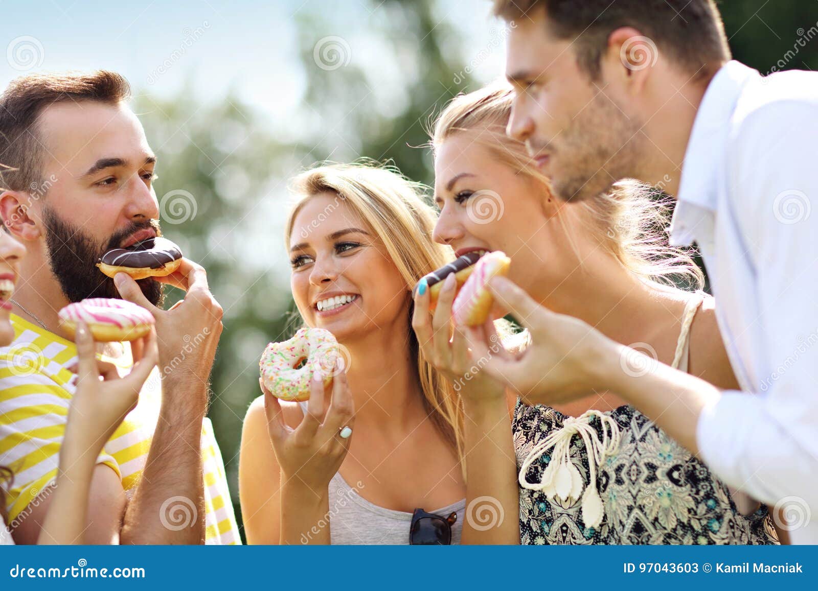 Group of Friends Eating Donuts Outdoors Stock Image - Image of ...
