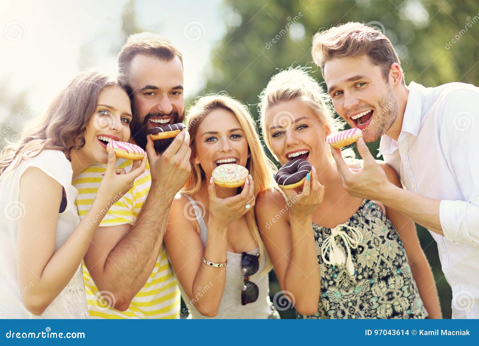 Group of Friends Eating Donuts Outdoors Stock Photo - Image of group ...