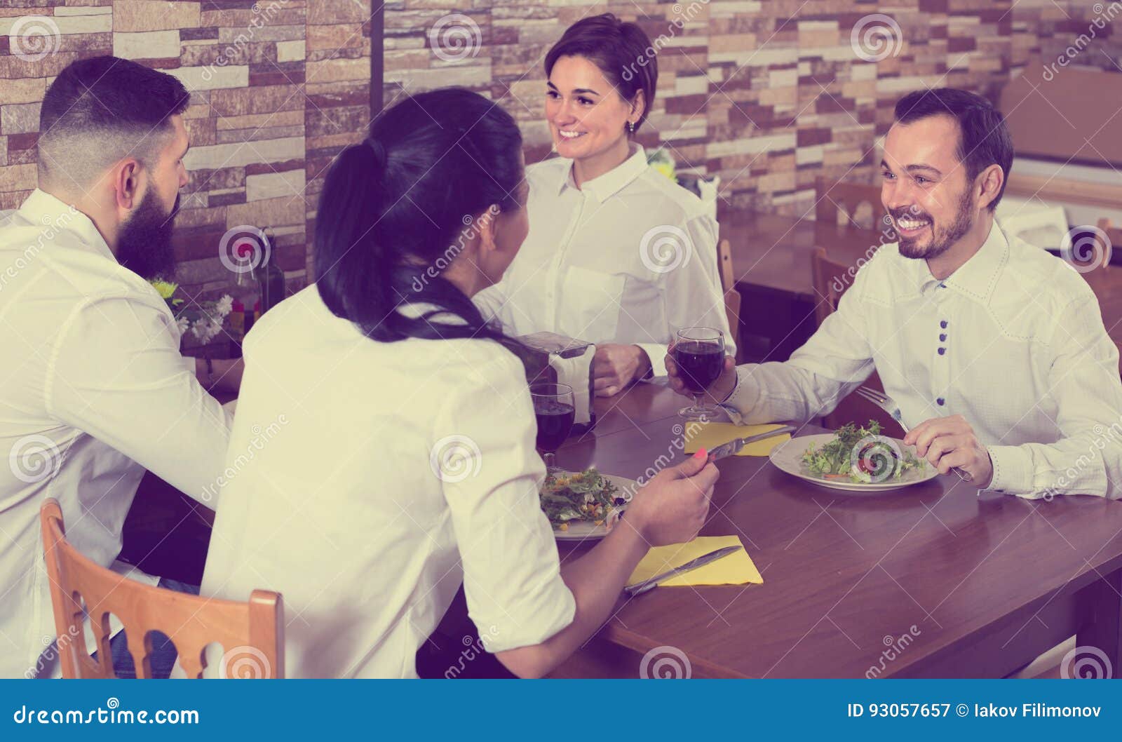 Group of Friends Eating at Restaurant and Chatting Stock Image - Image ...