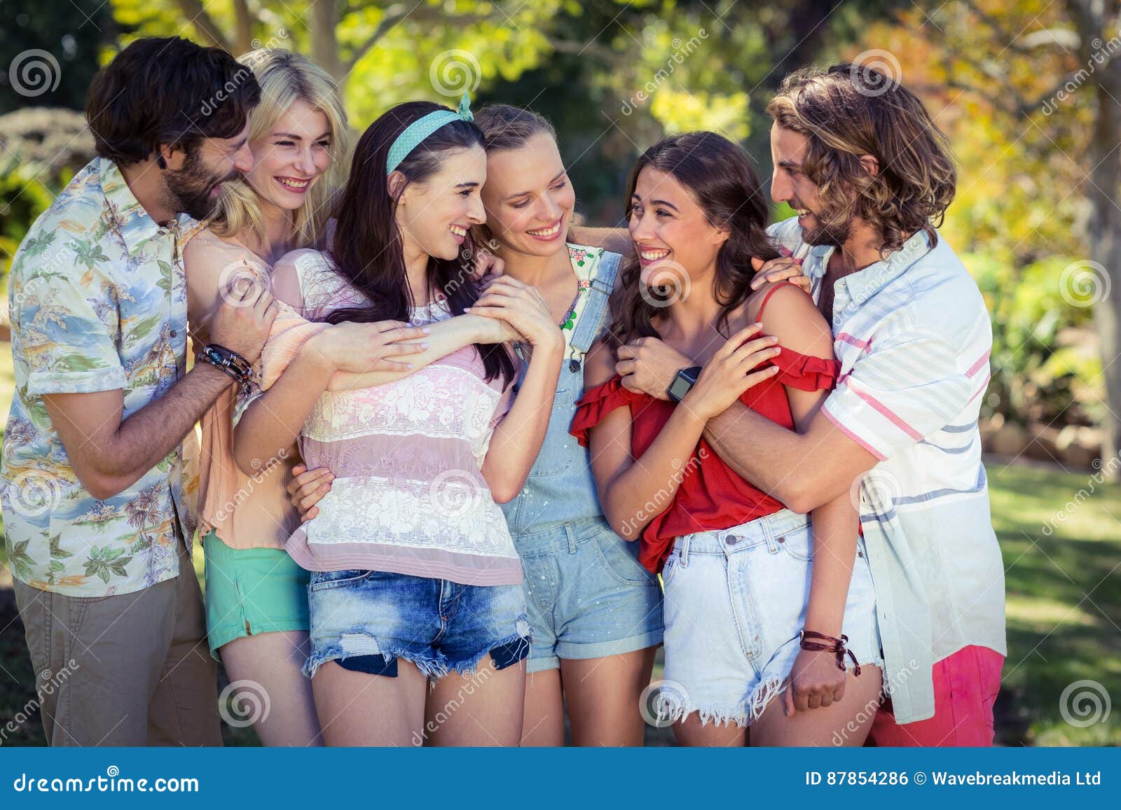 Group of Friends Embracing in Park Stock Photo - Image of friends ...