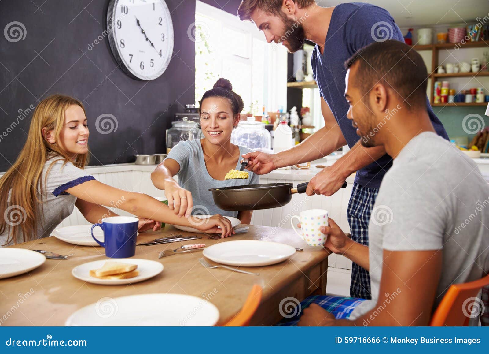 Group of Friends Enjoying Breakfast in Kitchen Together Stock Photo ...