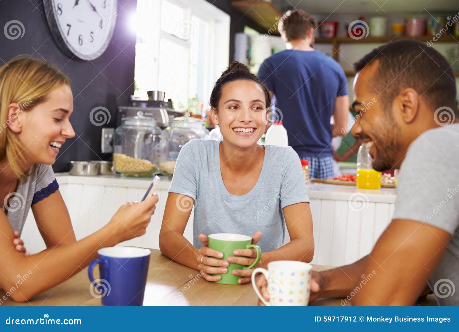 Group of Friends Enjoying Breakfast in Kitchen Together Stock Photo ...