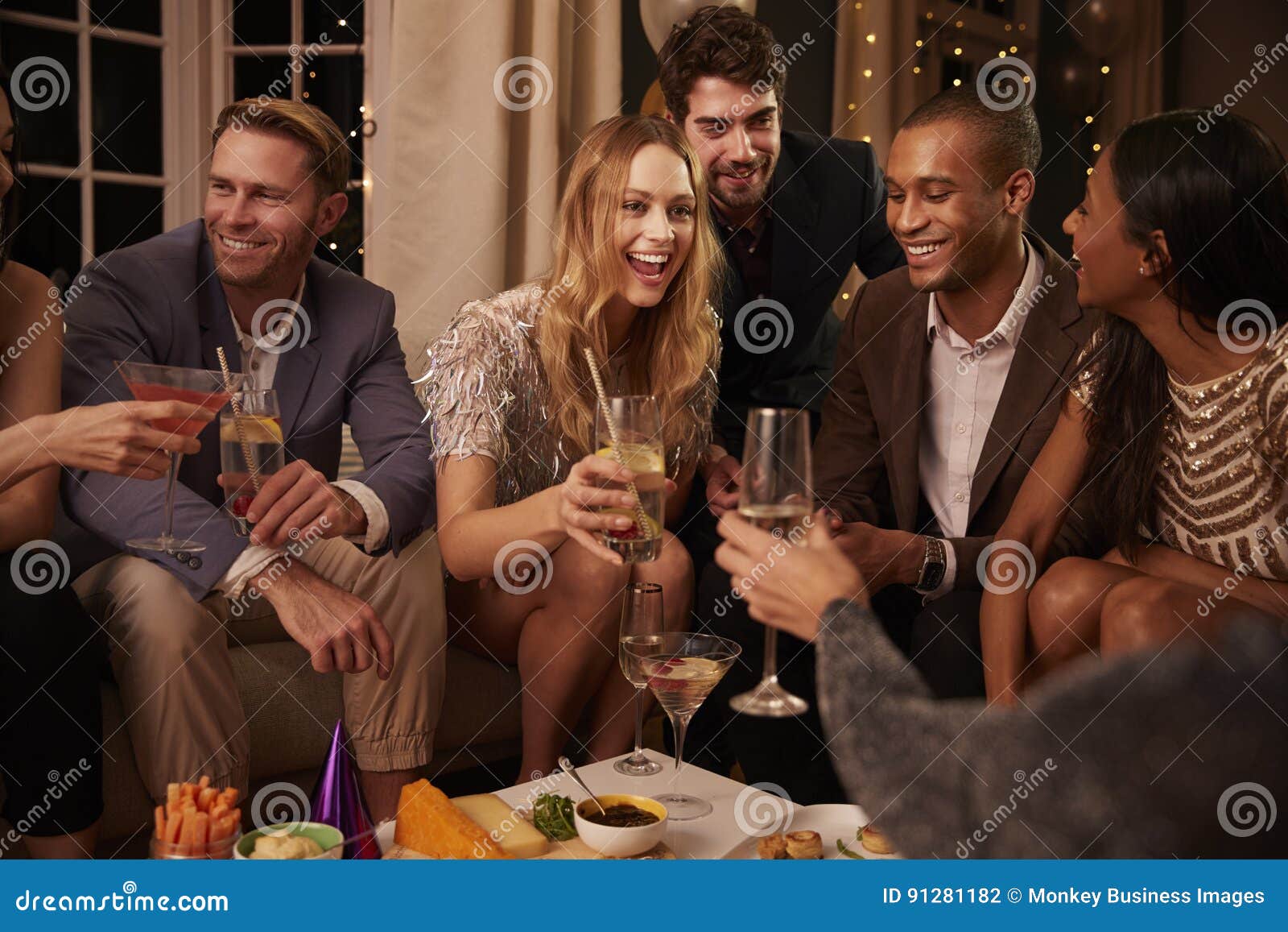 Group of Friends Enjoying Drinks and Snacks at Party Stock Photo ...
