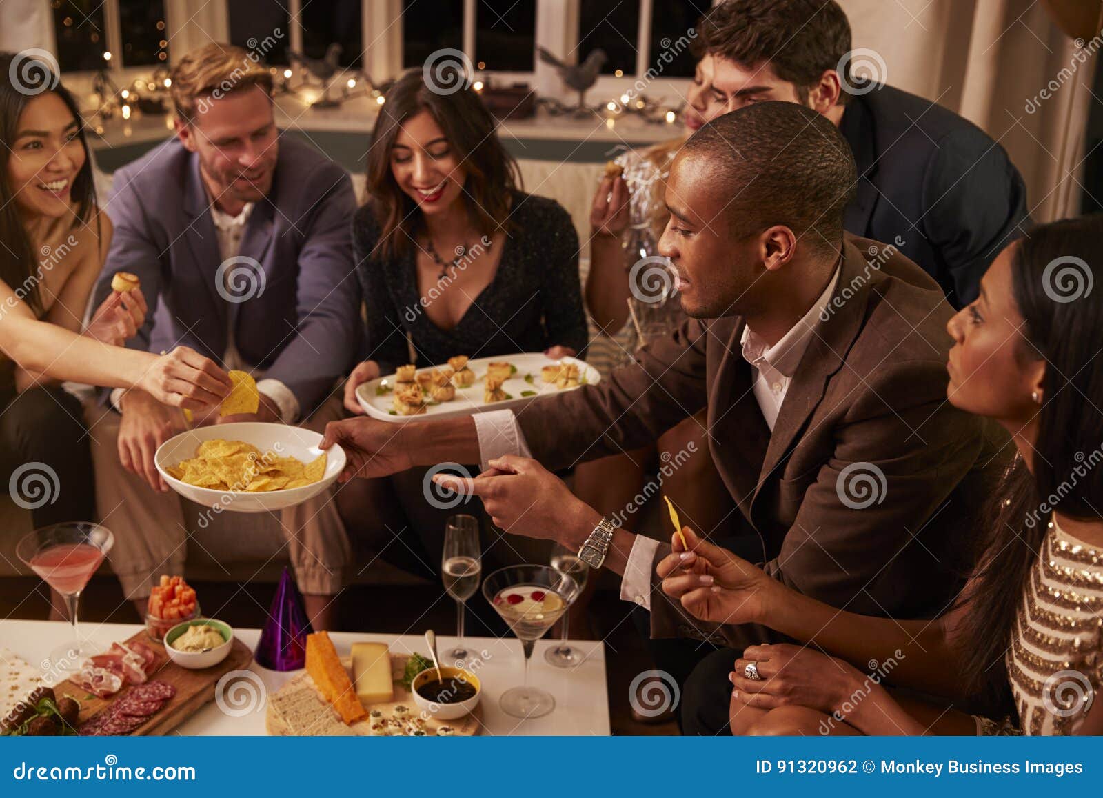 Group of Friends Enjoying Drinks and Snacks at Party Stock Photo ... Group of Friends Enjoying Drinks and Snacks at Party Stock Photo ...