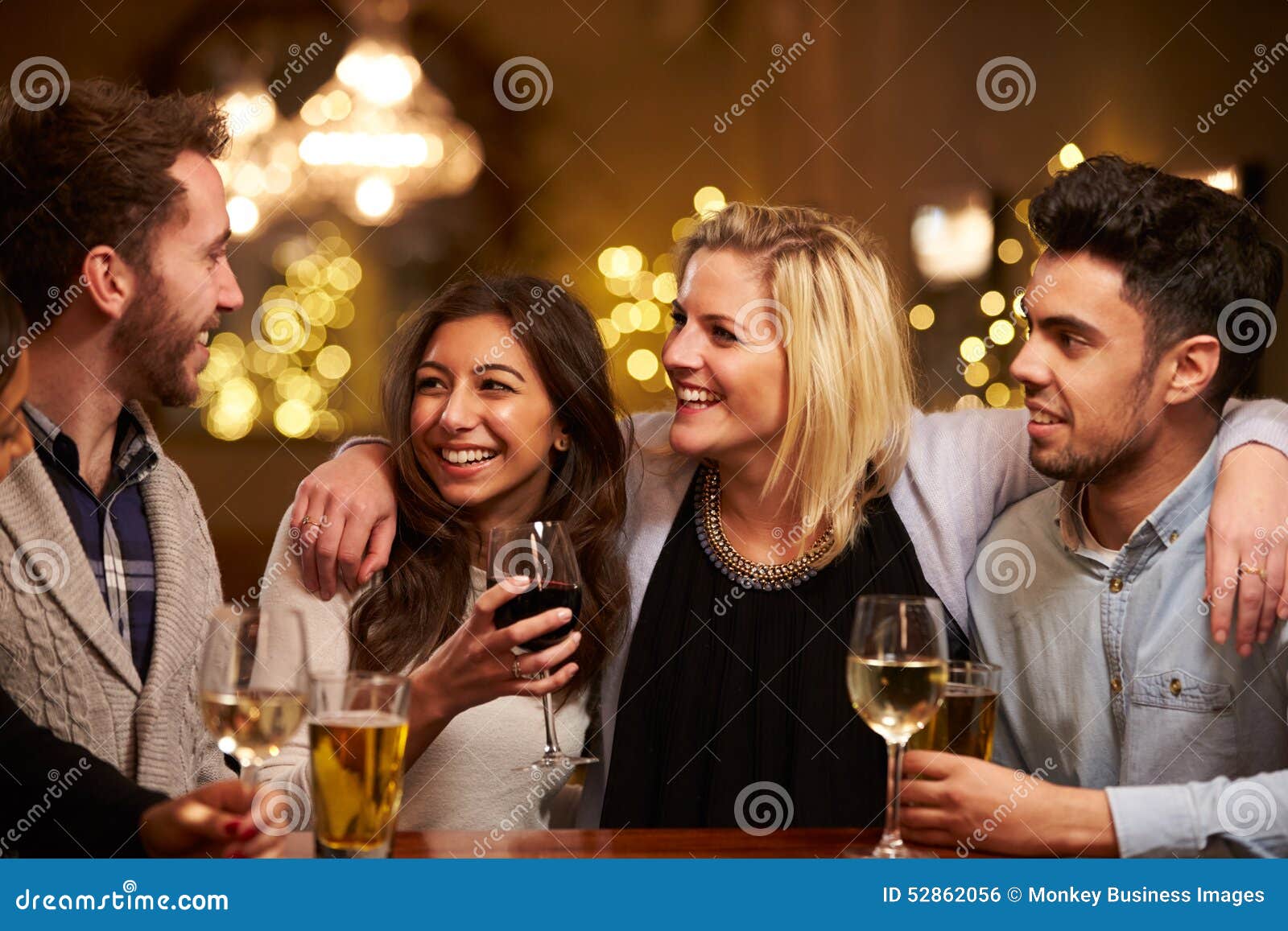 Group of Friends Enjoying Evening Drinks in Bar Stock Photo - Image of ...