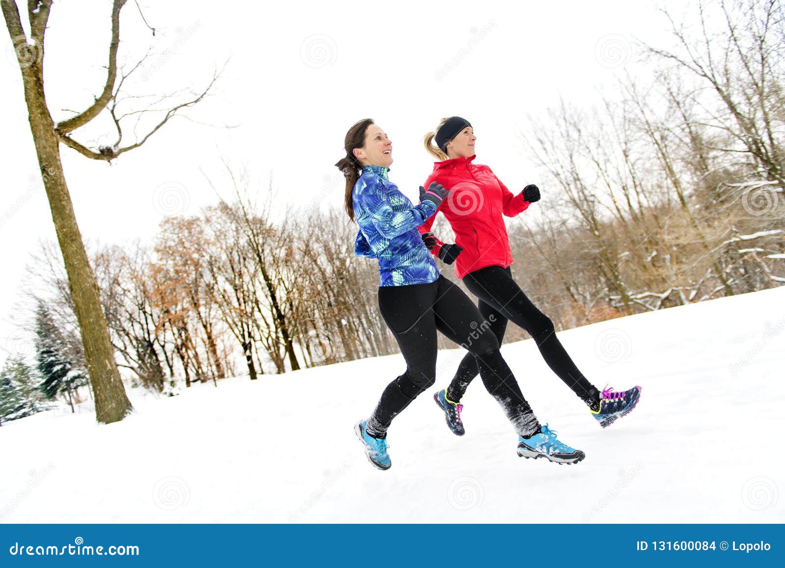 Group of Friends Enjoying Jogging in the Snow in Winter Stock Photo ...