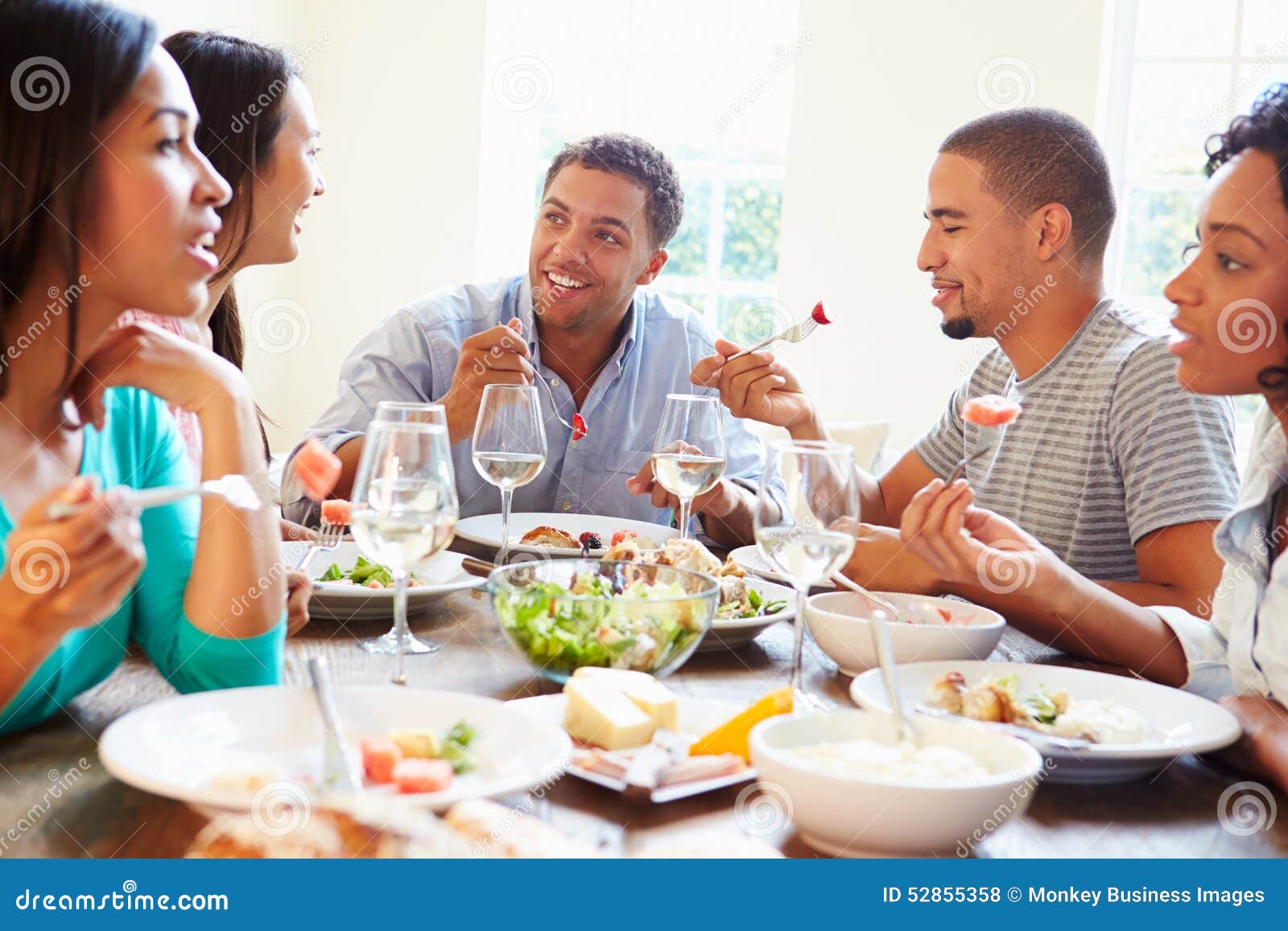 Group of Friends Enjoying Meal at Home Together Stock Photo - Image of ...
