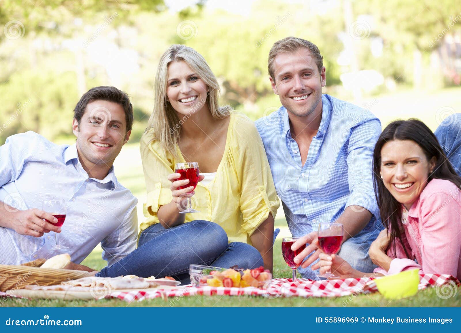 Group of Friends Enjoying Picnic Together Stock Image - Image of four ...