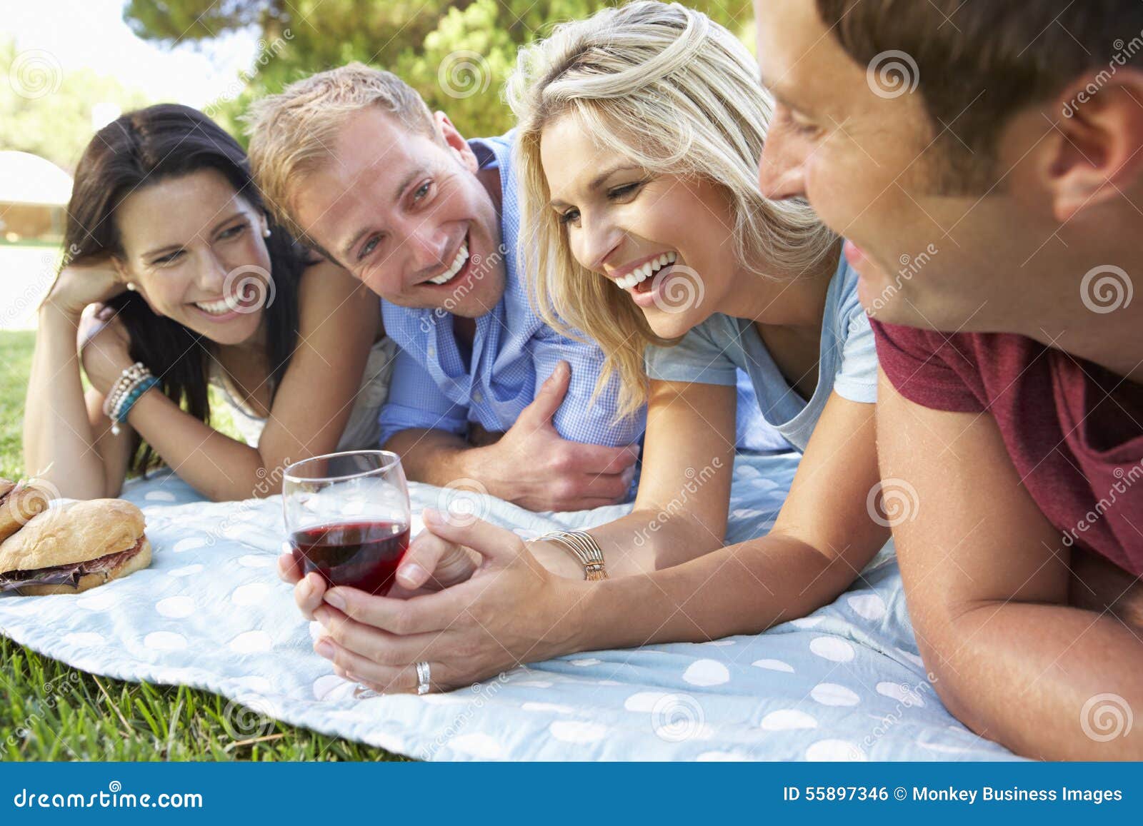 Group of Friends Enjoying Picnic Together Stock Photo - Image of group ...