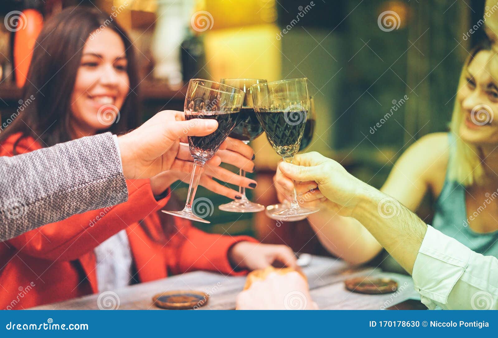 Group Of Friends Enjoying Red Wine In Speakeasy Vintage Bar Young