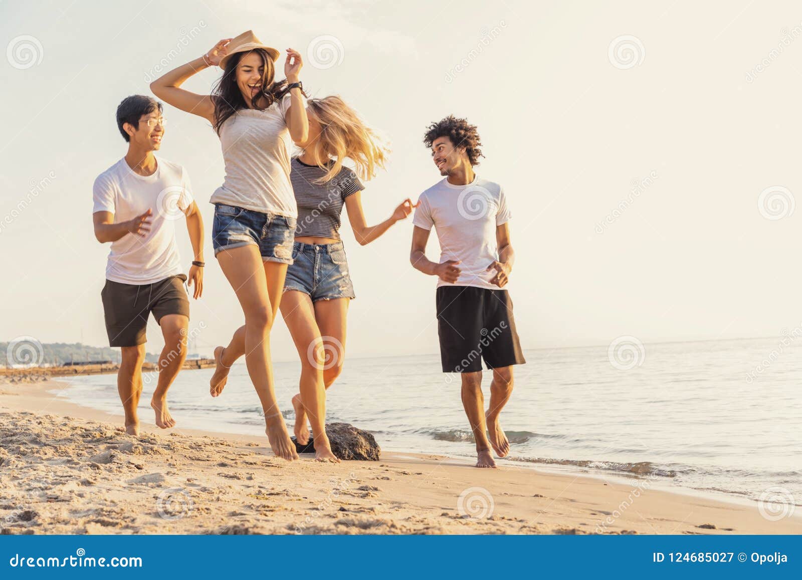 Group of Friends Having Fun Running Down the Beach at Sunset. Stock ...