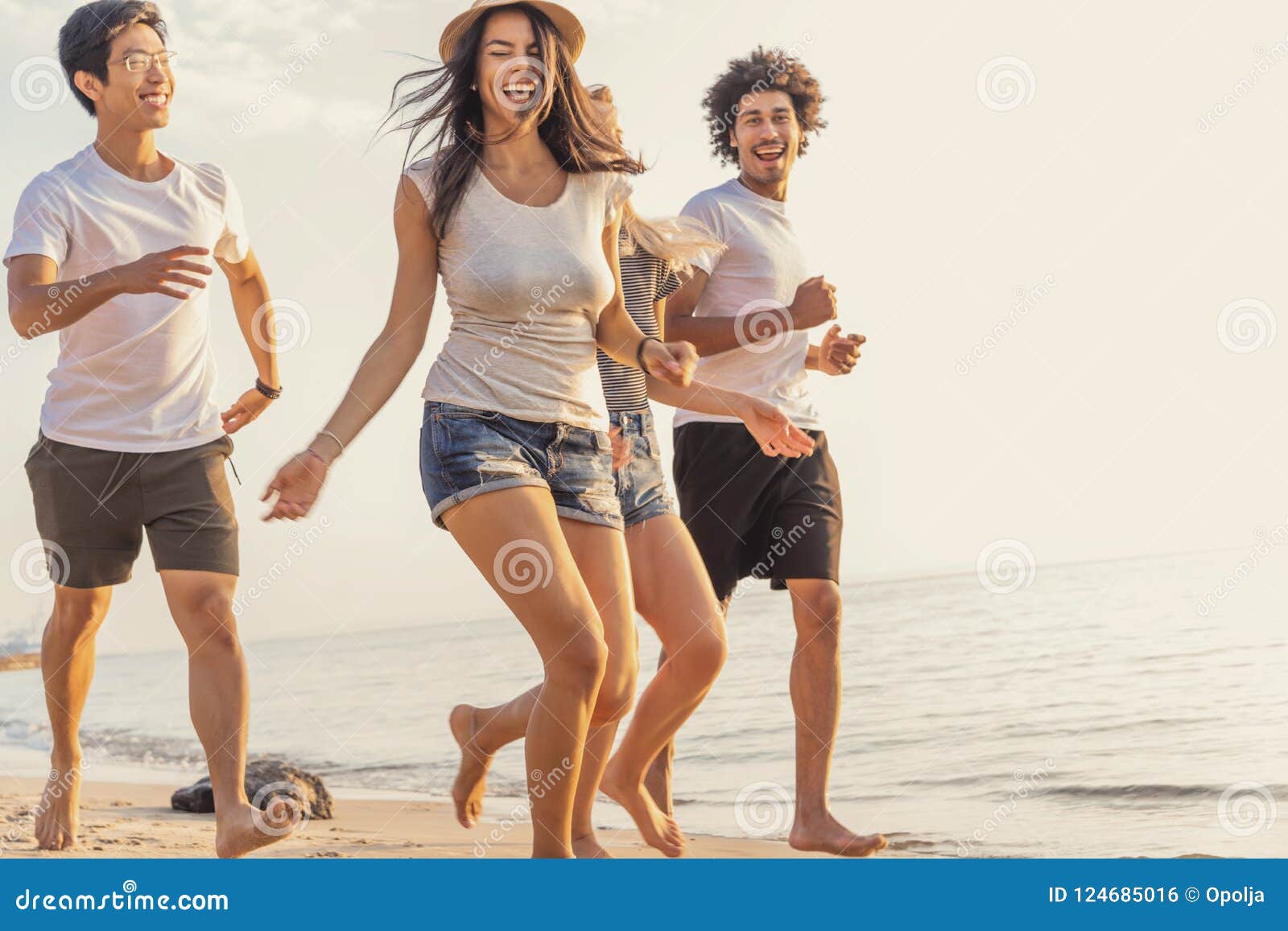 Group of Friends Having Fun Running Down the Beach at Sunset. Stock ...