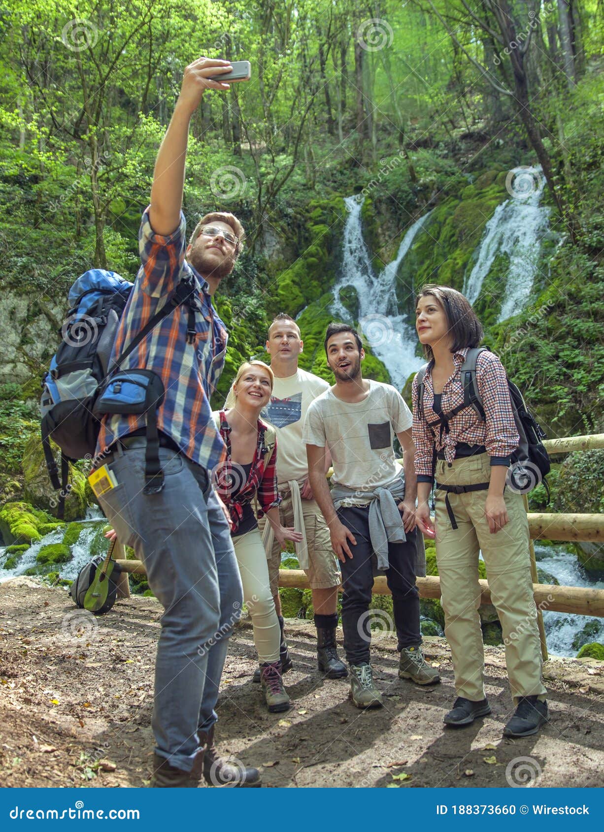 Group of Friends Having Fun and Taking Selfies in Front of a Waterfall ...