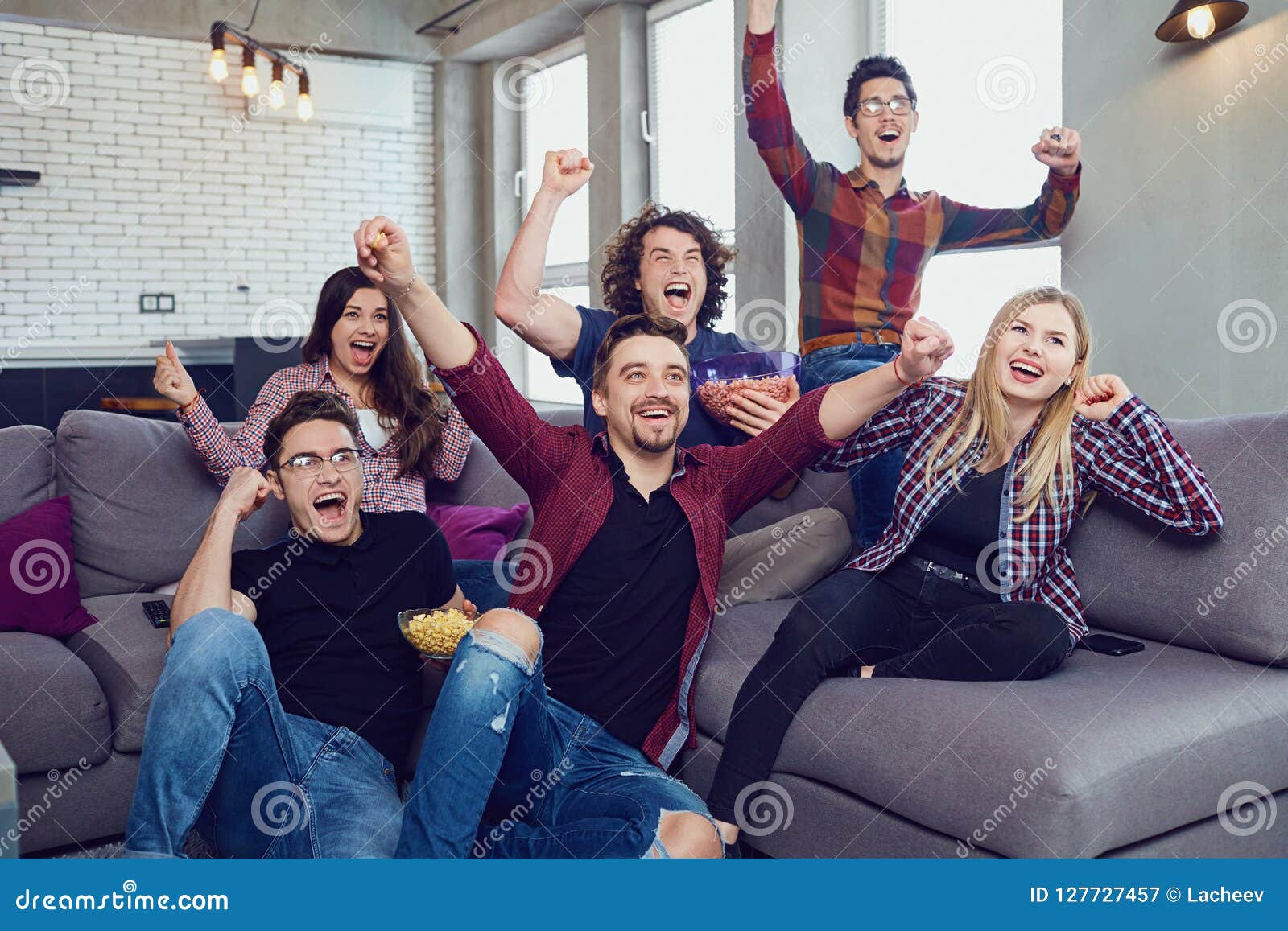 A Group of Friends are Having Fun Watching TV in the Room. Stock Image ...