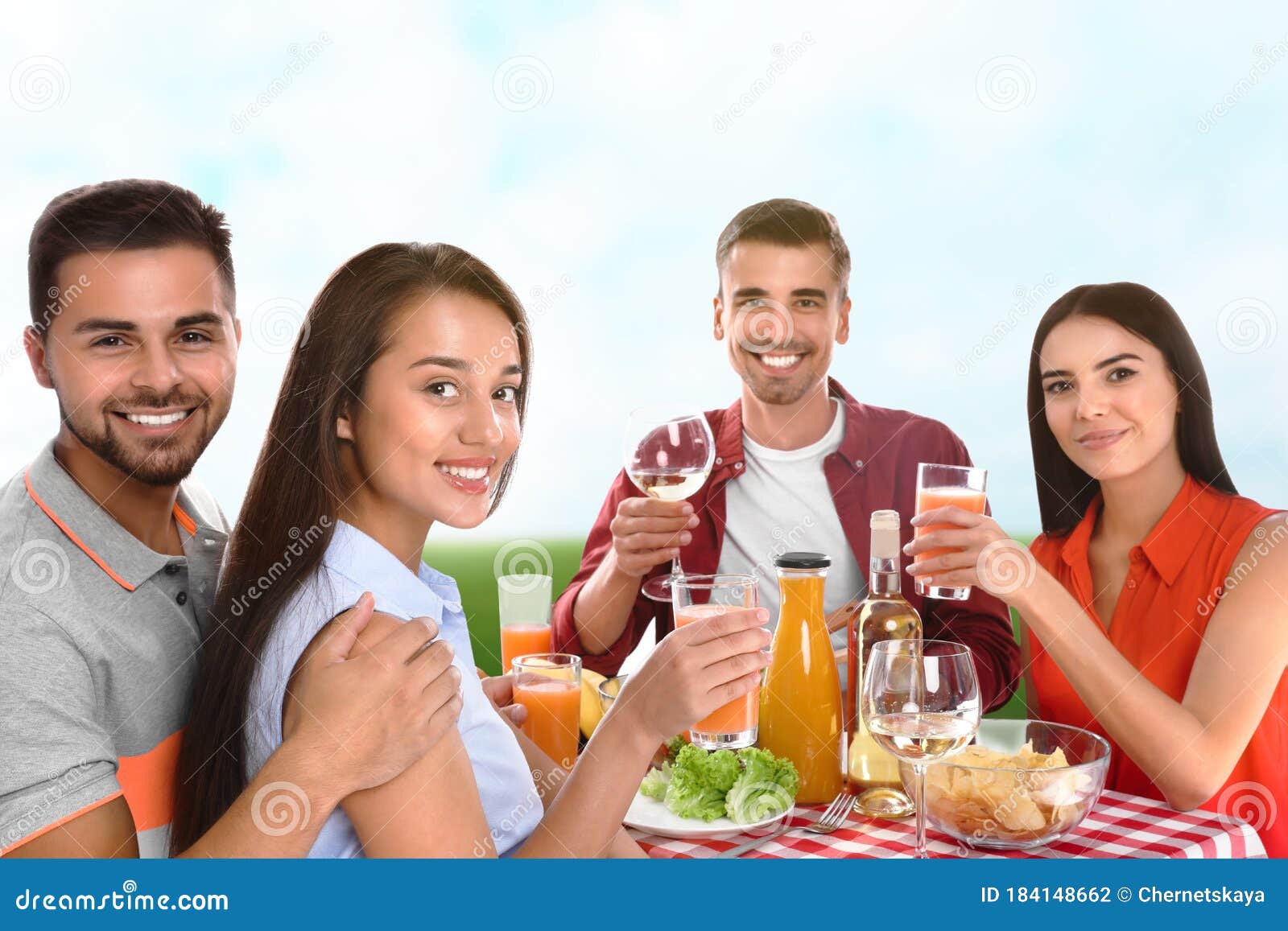 Friends Having Picnic at Table in Park Stock Photo - Image of morning ...