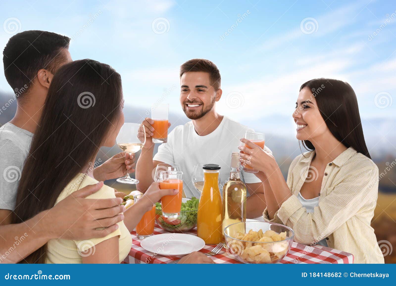 Friends Having Picnic at Table in Park Stock Photo - Image of lifestyle ...