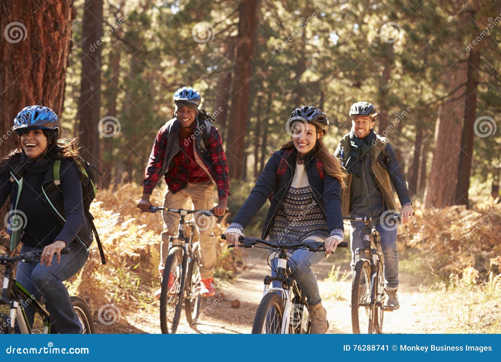 Group Friends in Helmets Riding Bikes in a Forest, Close Up Stock Image ...