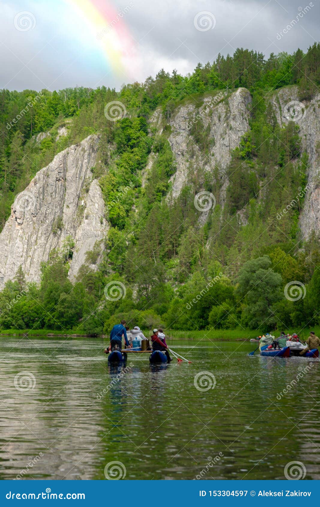 A Group of Friends in an Inflatable Raft Moving Down a River. Mountain ...