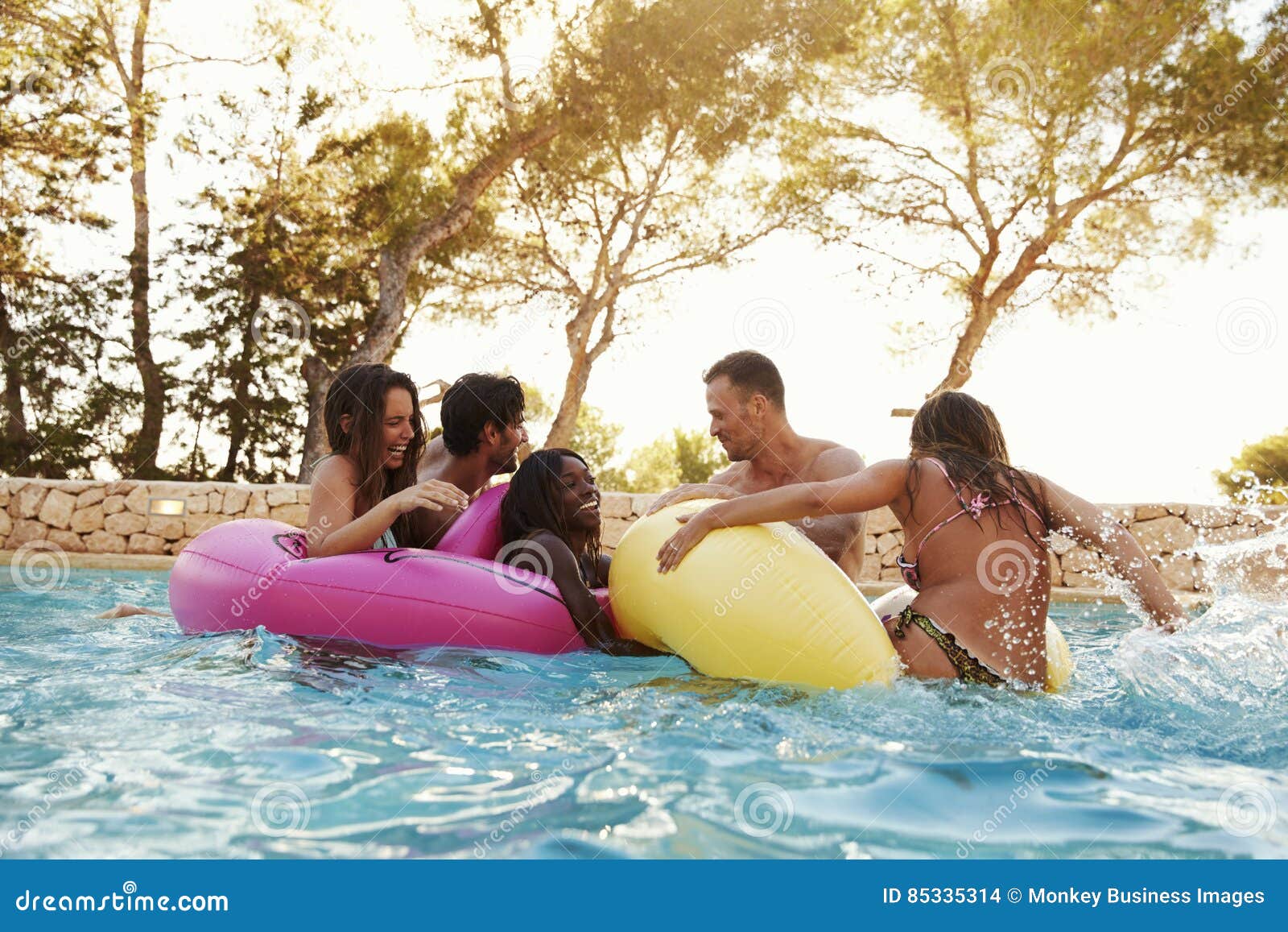 Group of Friends on Inflatables in Outdoor Pool Stock Photo - Image of ...