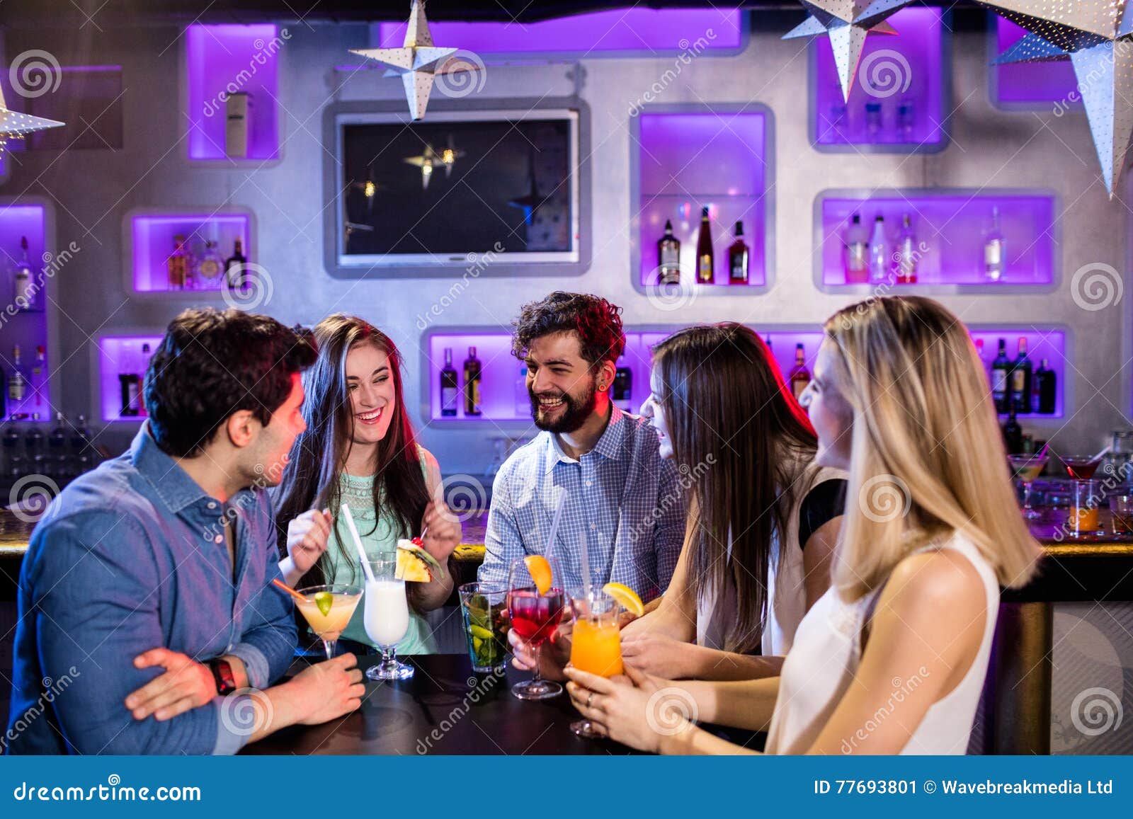 Group of Friends Interacting with Each Other at Bar Counter while ...