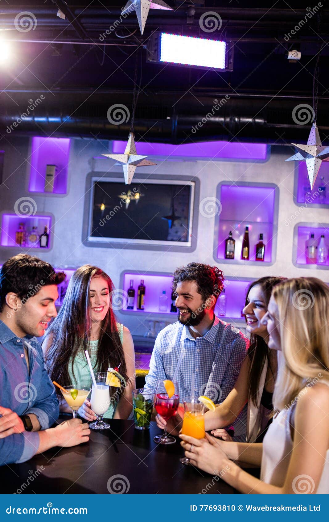 Group of Friends Interacting with Each Other at Bar Counter while ...