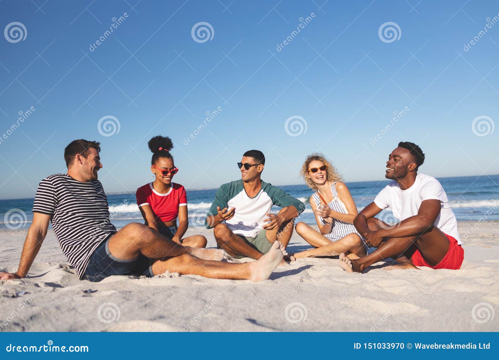 Group of Friends Interacting with Each Other on the Beach Stock Photo ...
