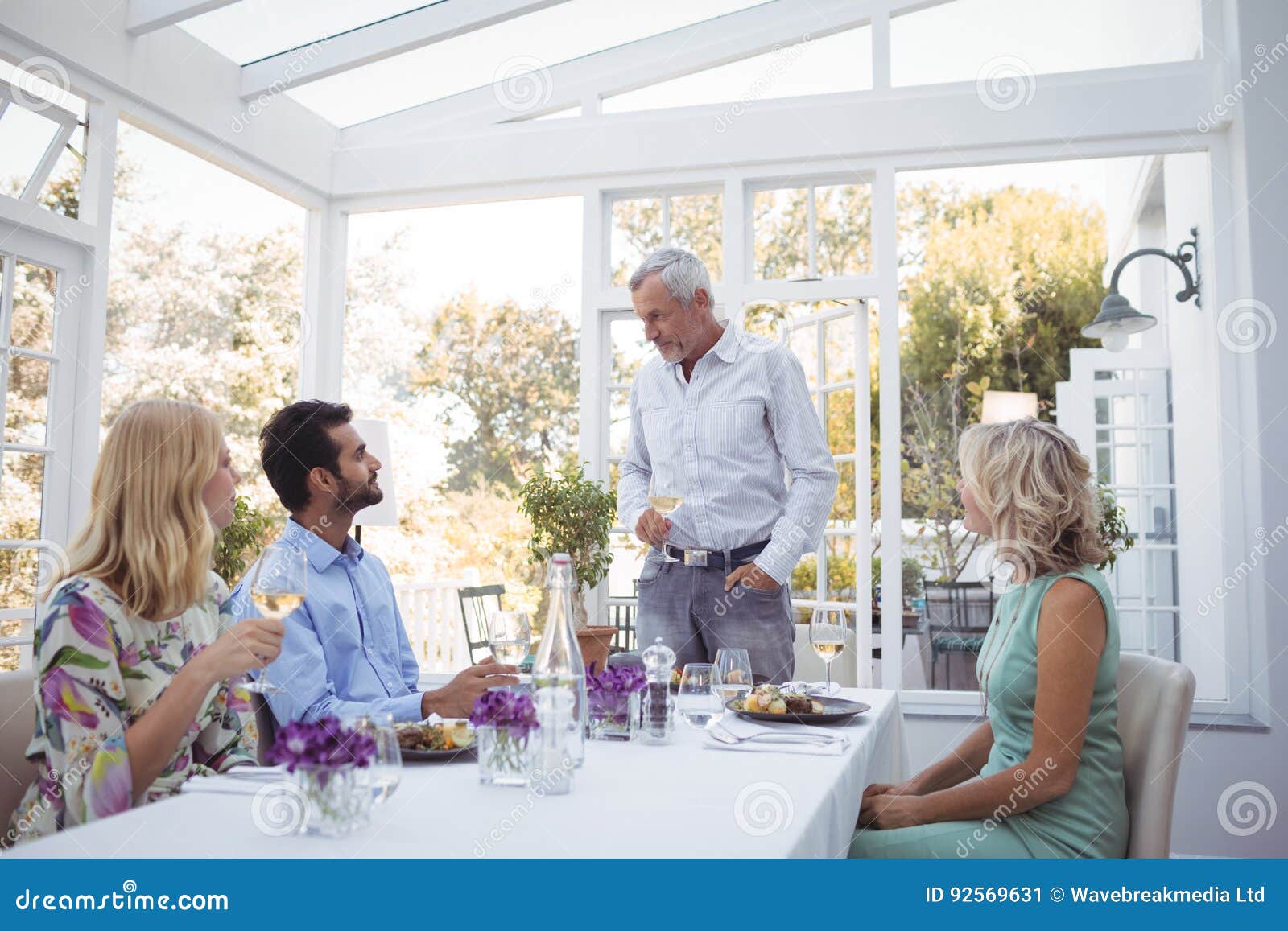 Group of Friends Interacting with Each Other while Having Meal Together ...