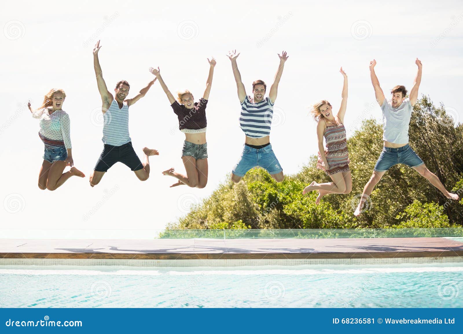 Group of Friends Jumping at Poolside Stock Image - Image of hands ...