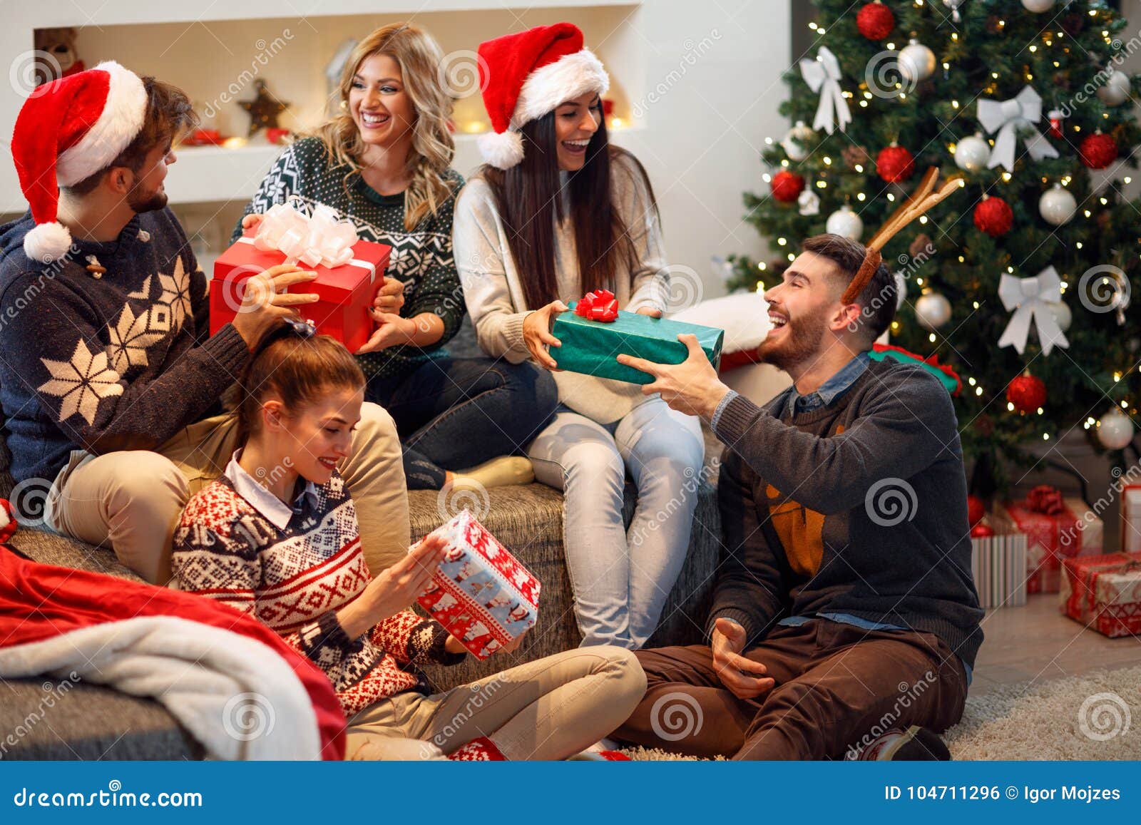 Friends Laughing and Sharing Christmas Gifts Stock Photo - Image of ...