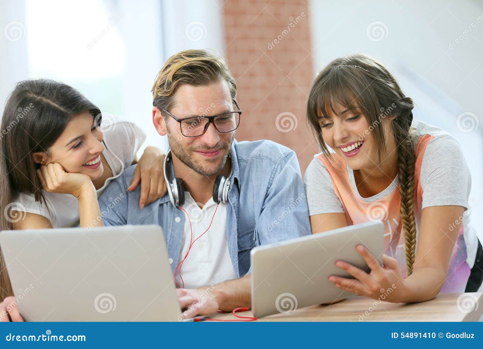 Group of Friends Laughing Using Tablet and Laptop Stock Photo - Image ...