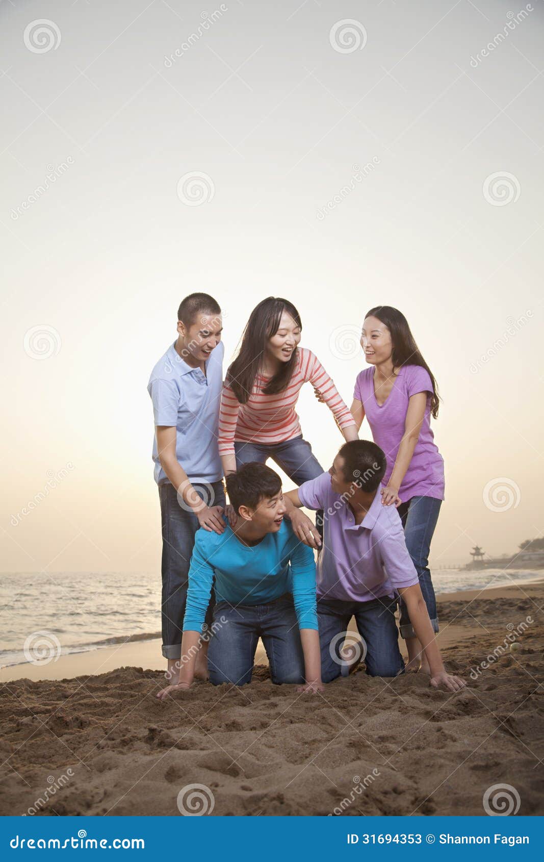 Group of Friends Making Human Pyramid on the Beach Stock Image - Image ...