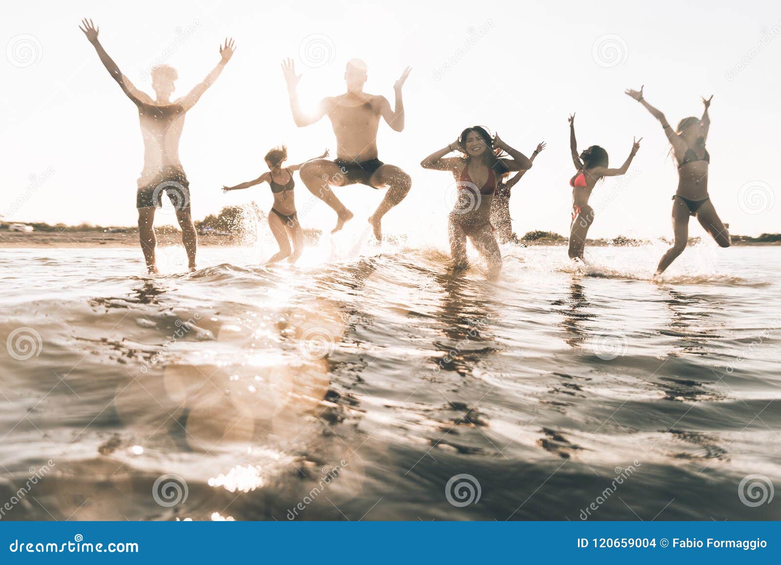 Group of Friends Making Party on the Beach at Sunset Time Stock Photo ...