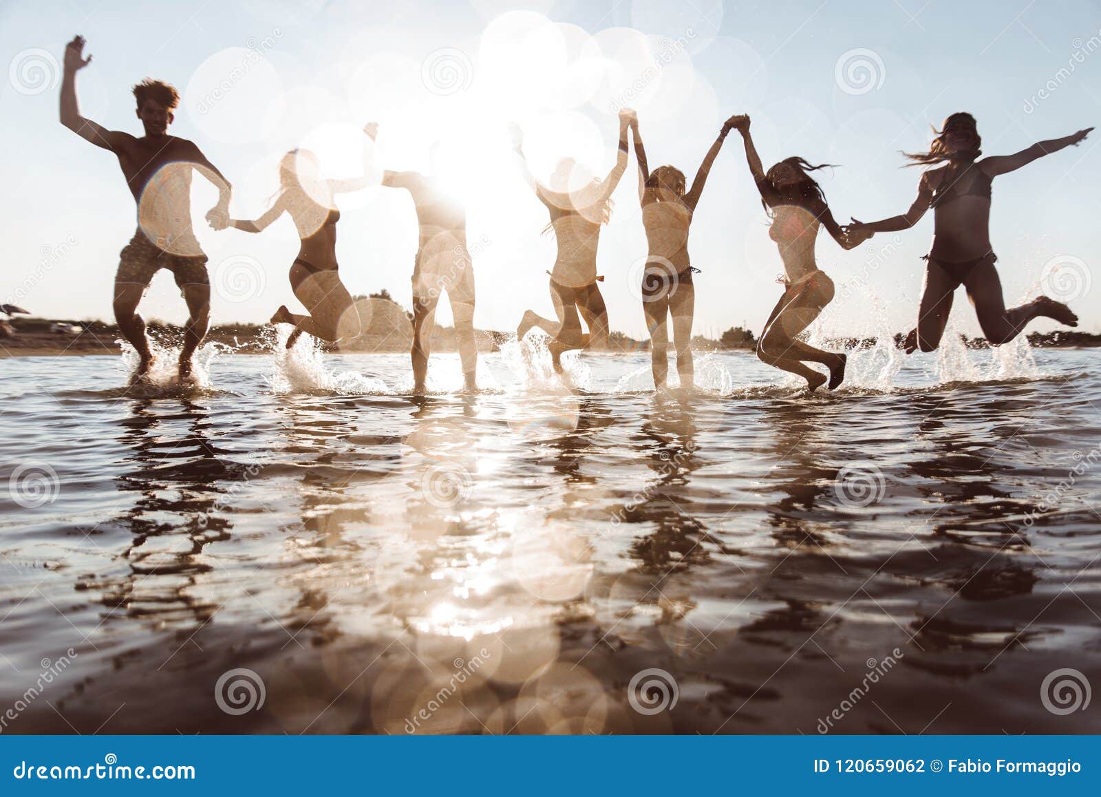 Group of Friends Making Party on the Beach at Sunset Time Stock Photo ...