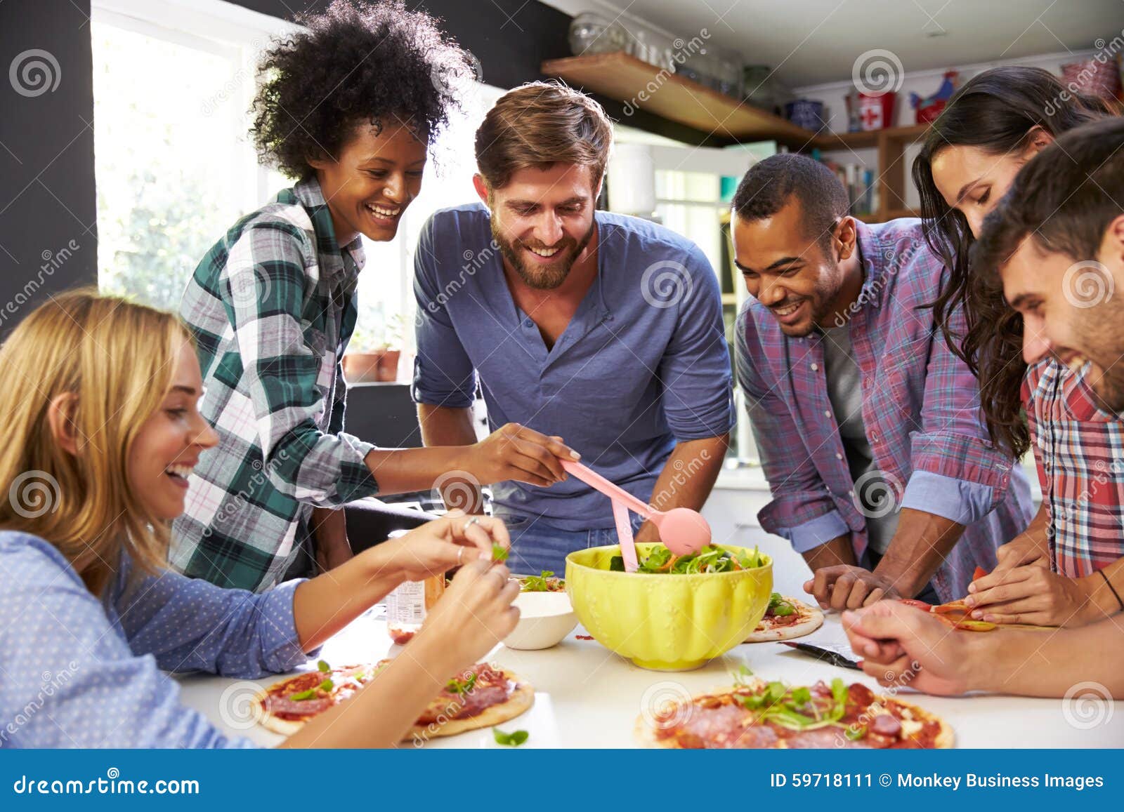 Group of Friends Making Pizza in Kitchen Together Stock Image - Image ...