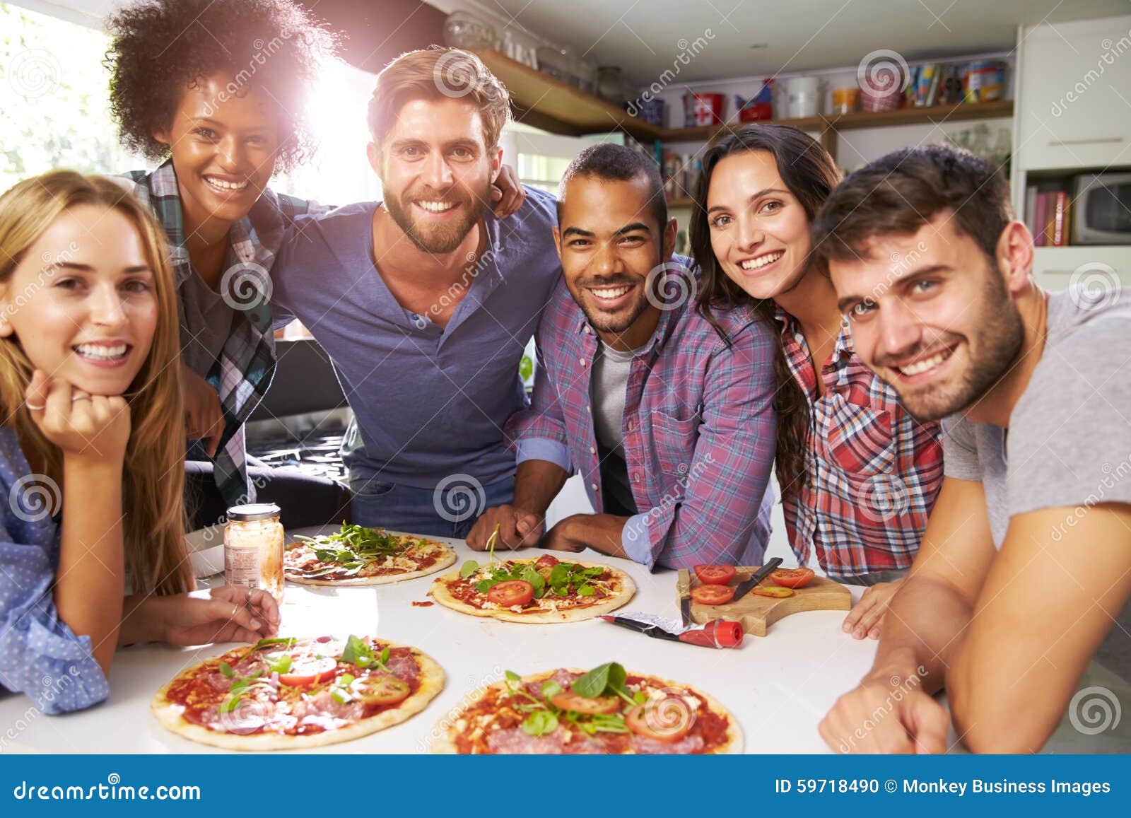 Group of Friends Making Pizza in Kitchen Together Stock Photo - Image ...