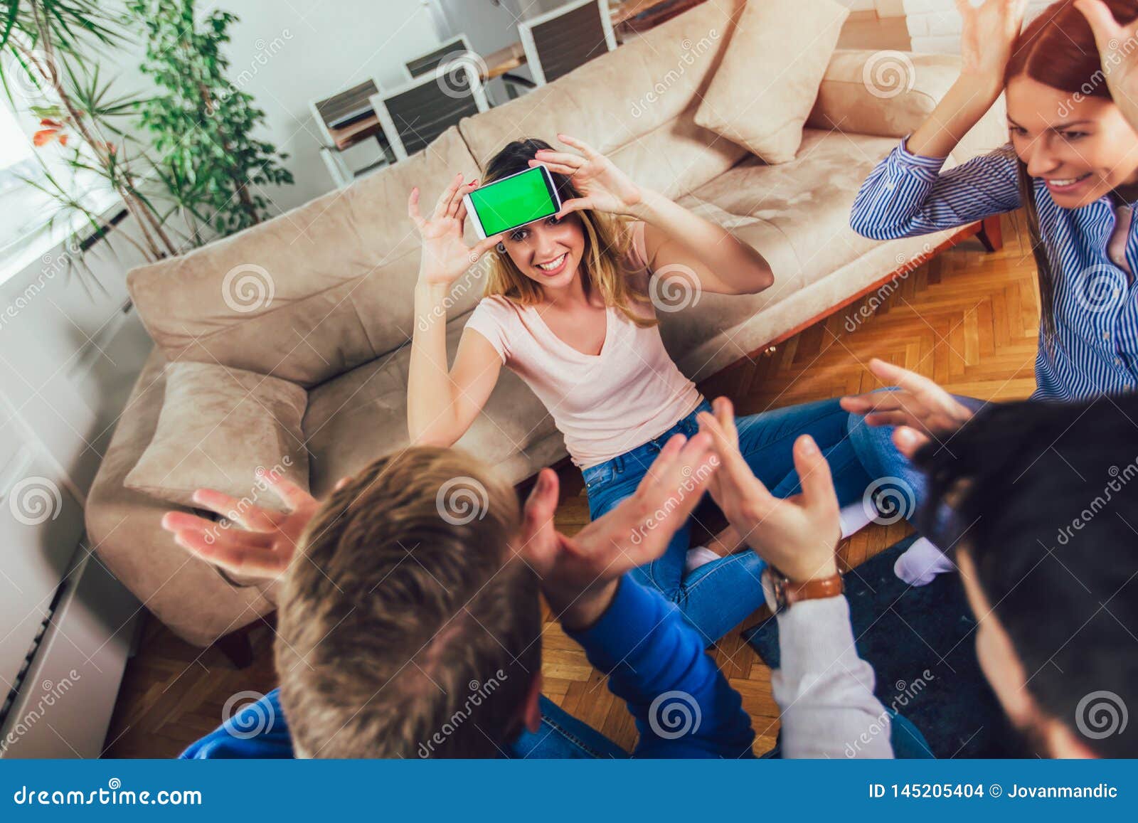 Group of Friends Playing Charades at Home Stock Photo - Image of ...