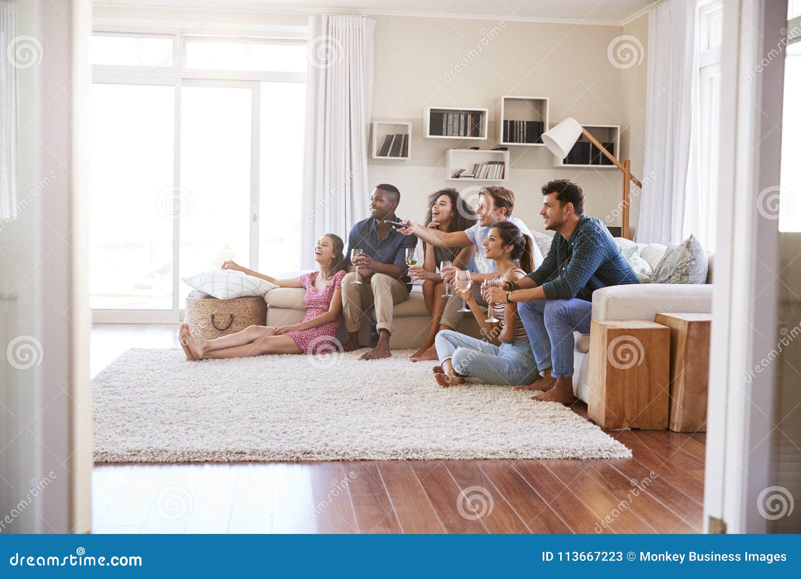 Group of Friends Relaxing at Home Watching TV Together Stock Image ...