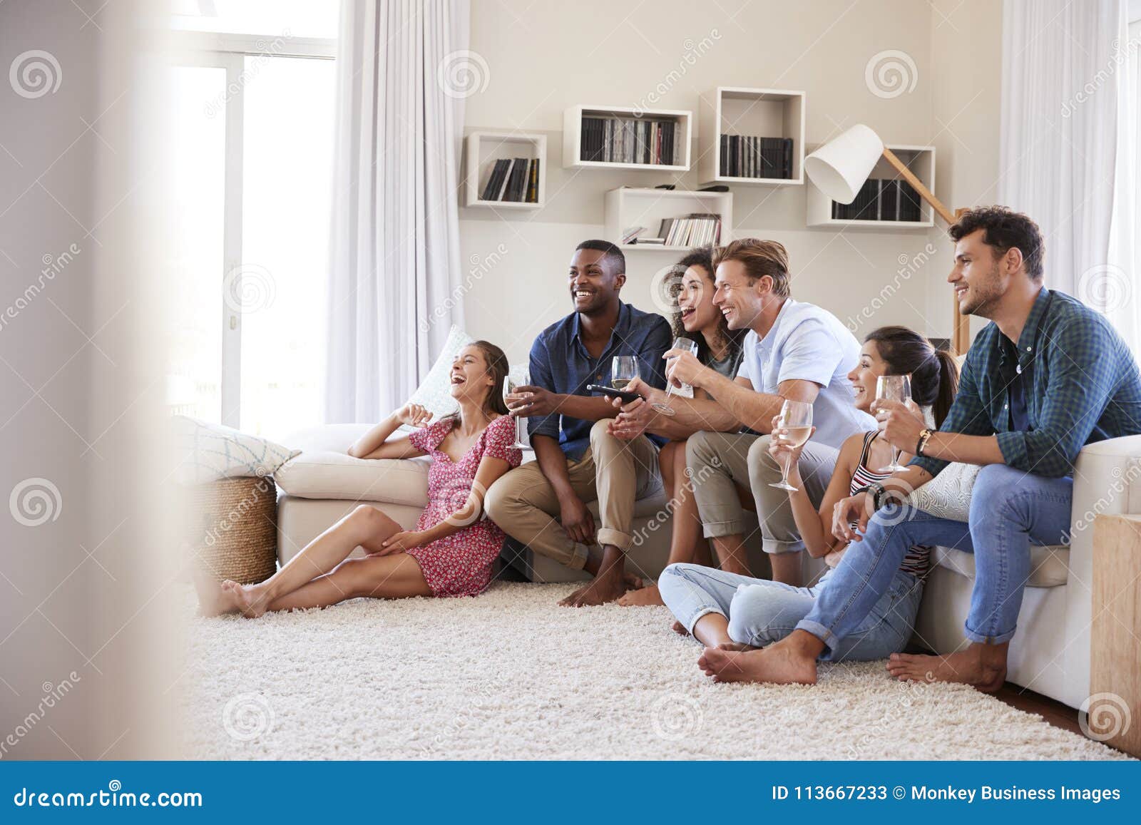 Group of Friends Relaxing at Home Watching TV Together Stock Image ...