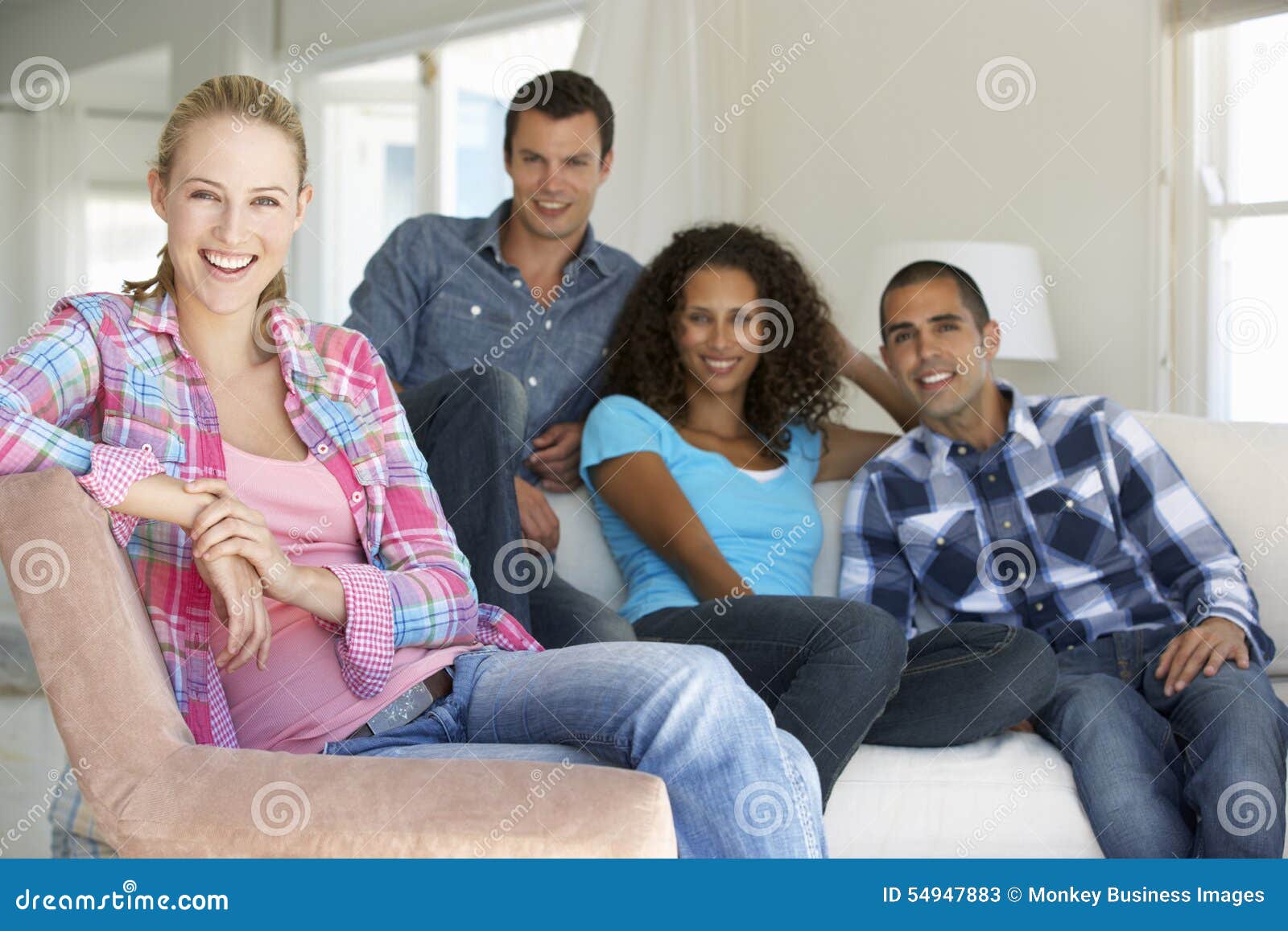 Group of Friends Relaxing on Sofa at Home Together Stock Image - Image ...
