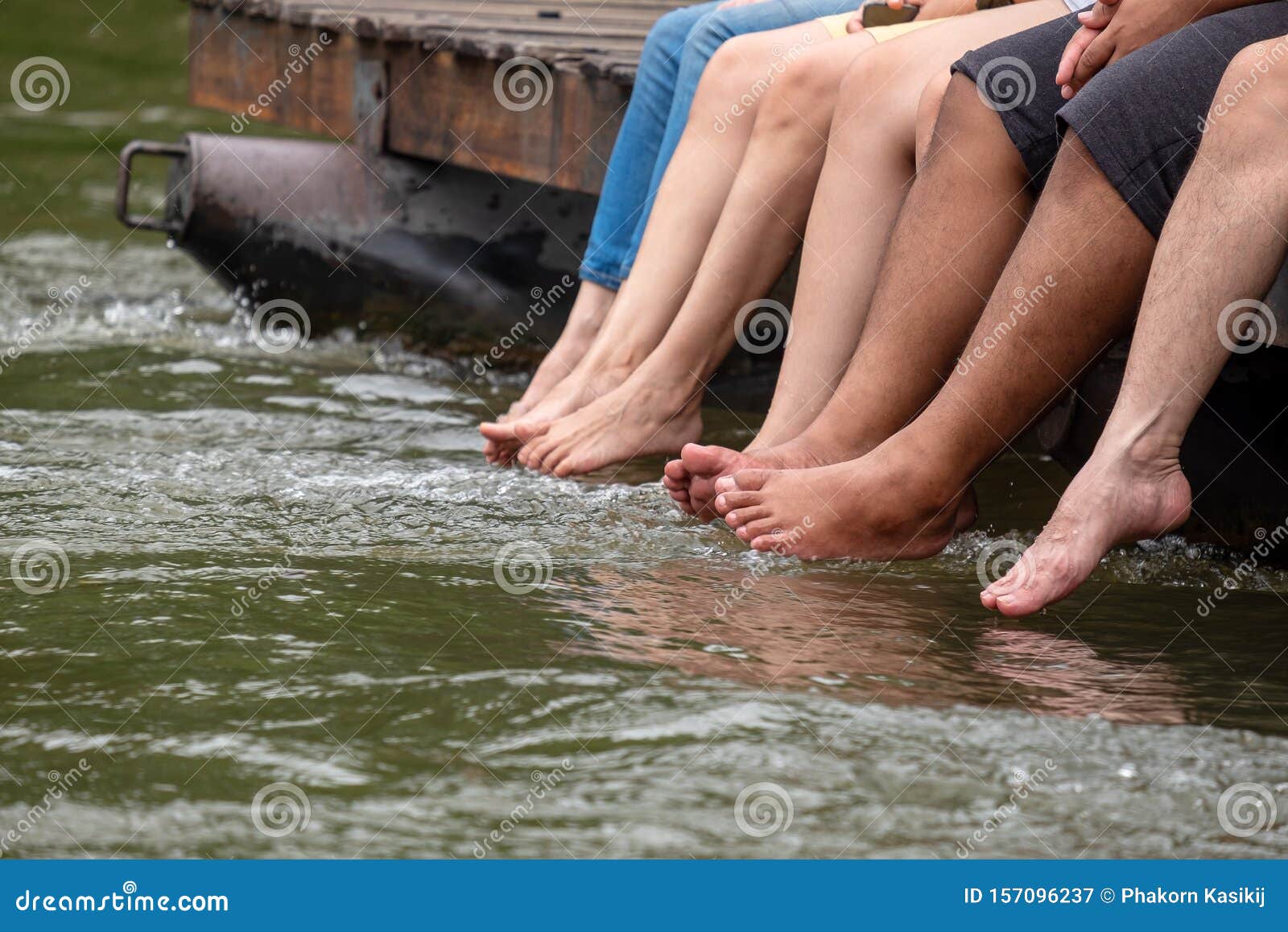 Group of Friends Relaxing on the Wooden Float Above the River Stock ...