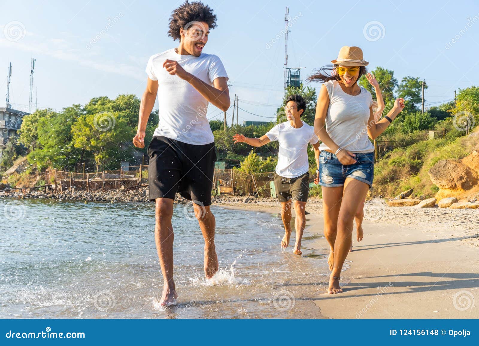 Group of Friends Run through Waves Together on Beach Vacation. Stock ...