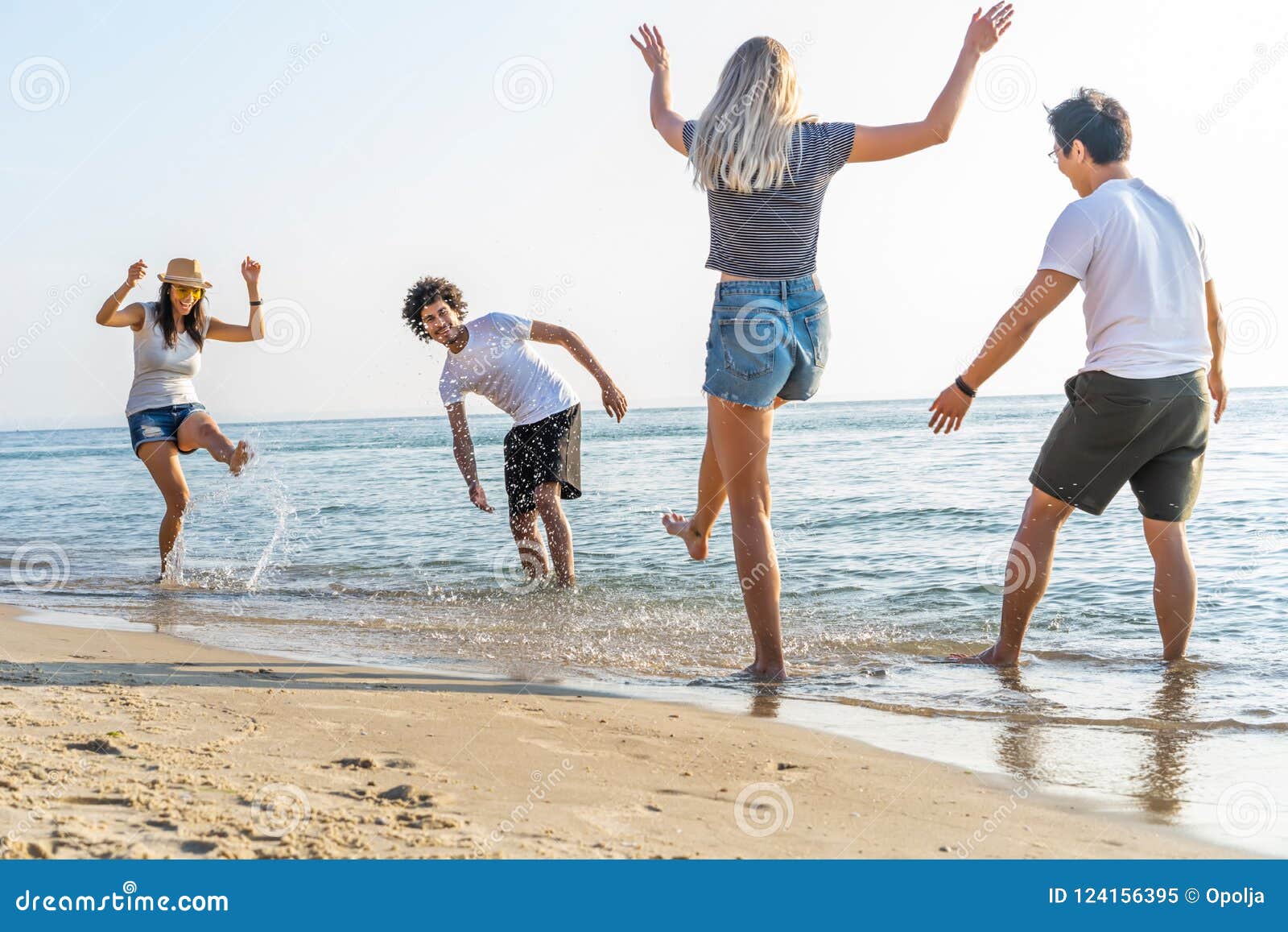 Group of Friends Run through Waves Together on Beach Vacation. Stock ...