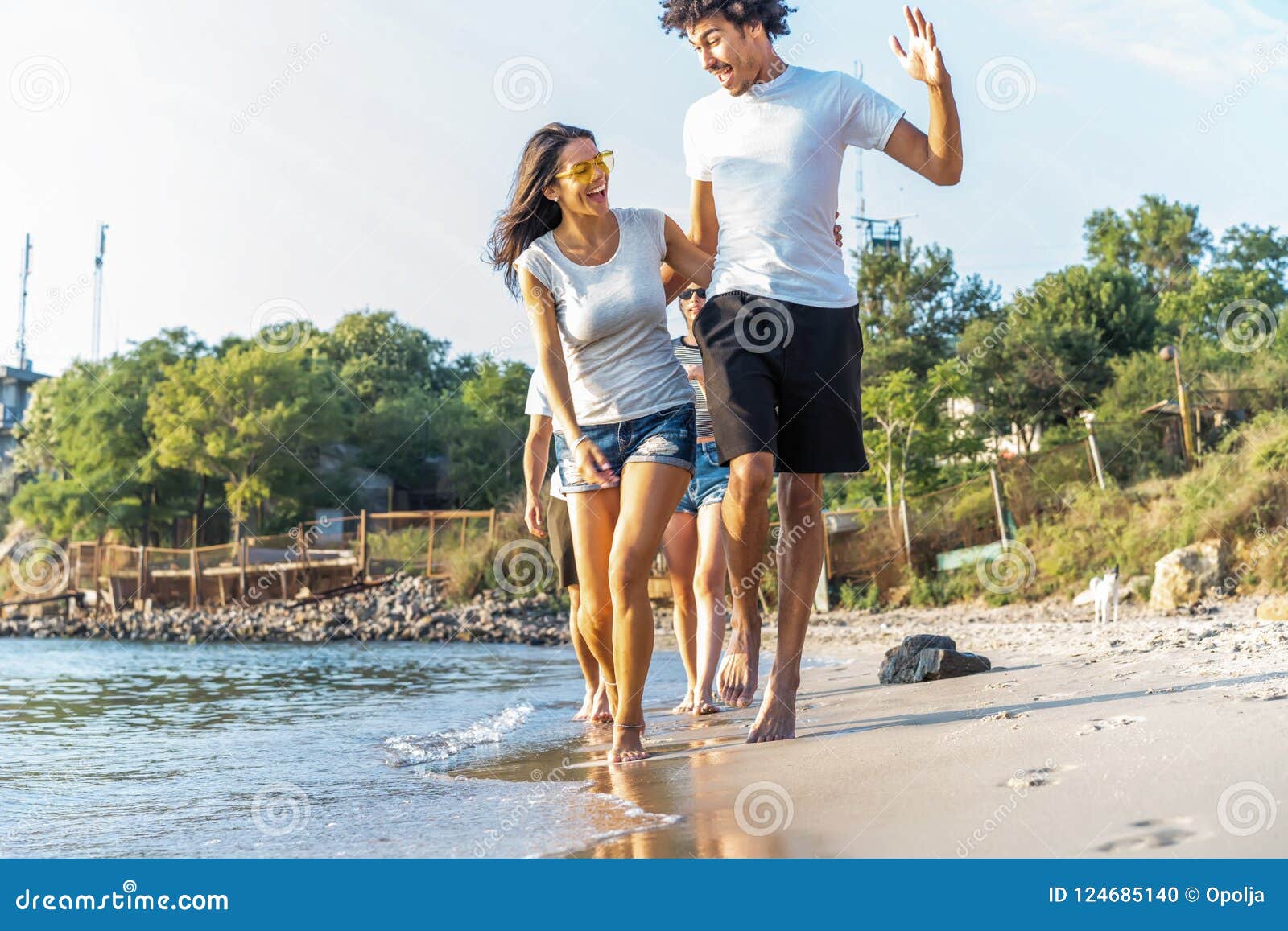 Group of Friends Run through Waves Together on Beach Vacation. Stock ...