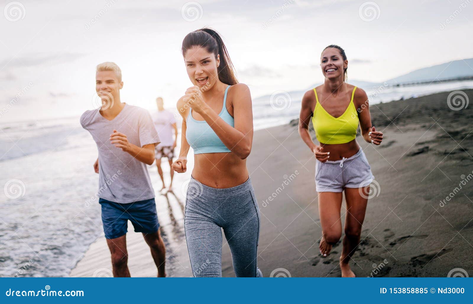 Group of Friends Running at the Beach on Beautiful Summer Sunset Stock ...