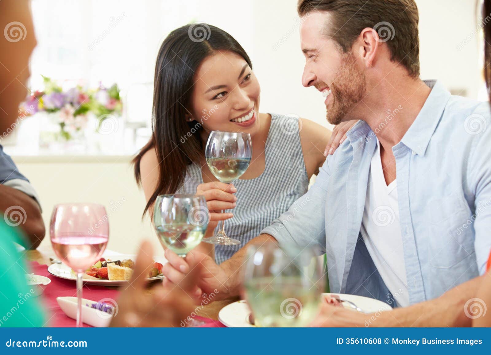 Group of Friends Sitting Around Table Having Dinner Party Stock Photo ...