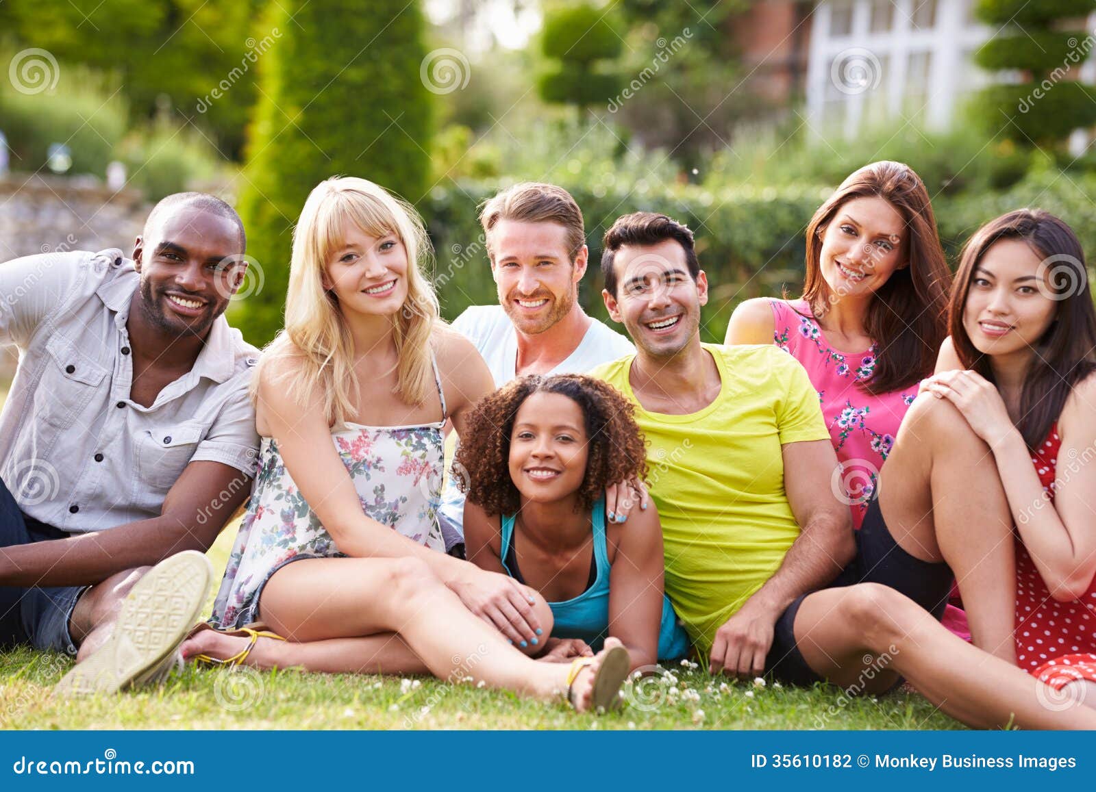 Group of Friends Sitting on Grass Together Stock Photo - Image of ...