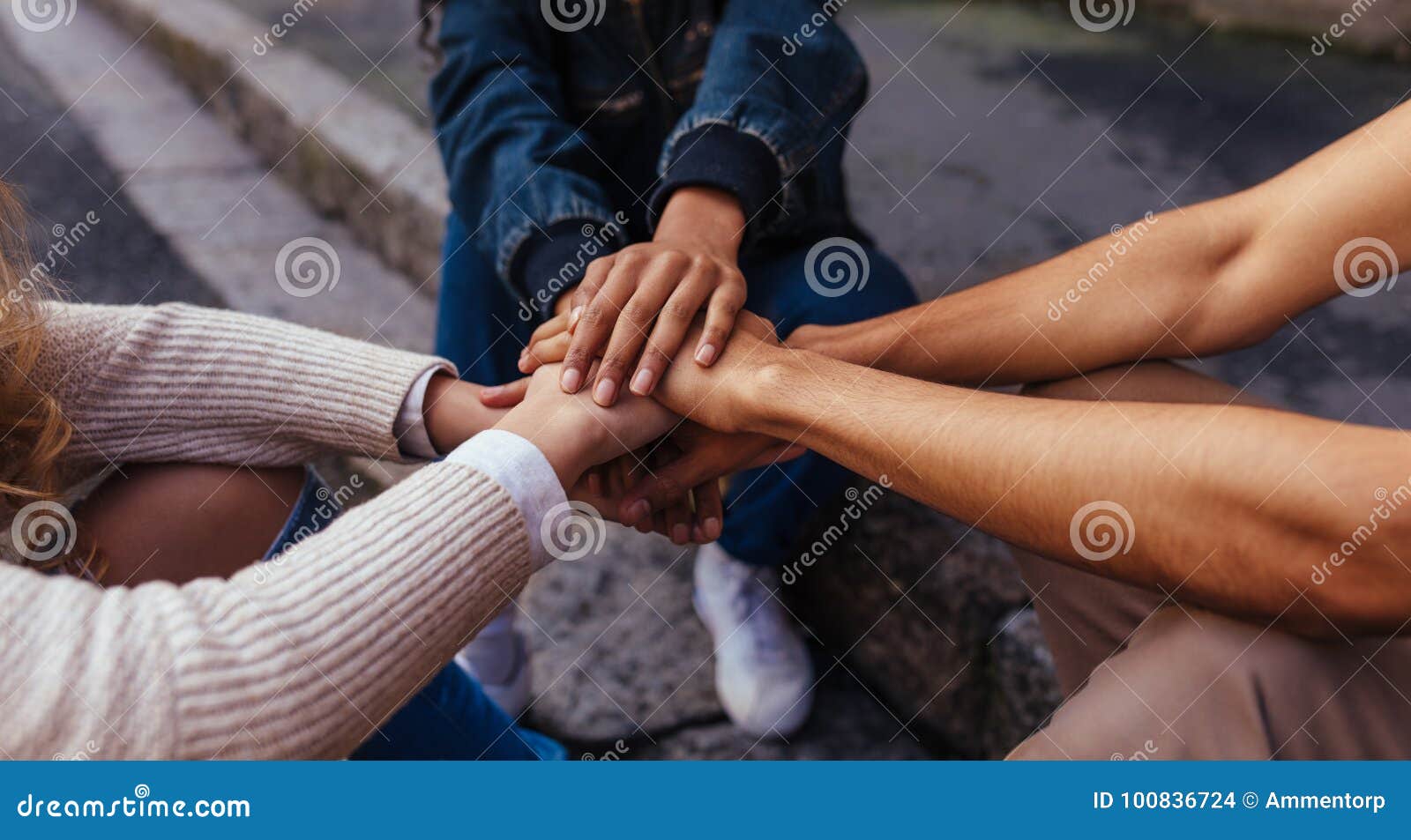Group of Friends Sitting Together Stacking Their Hands on One an Stock ...
