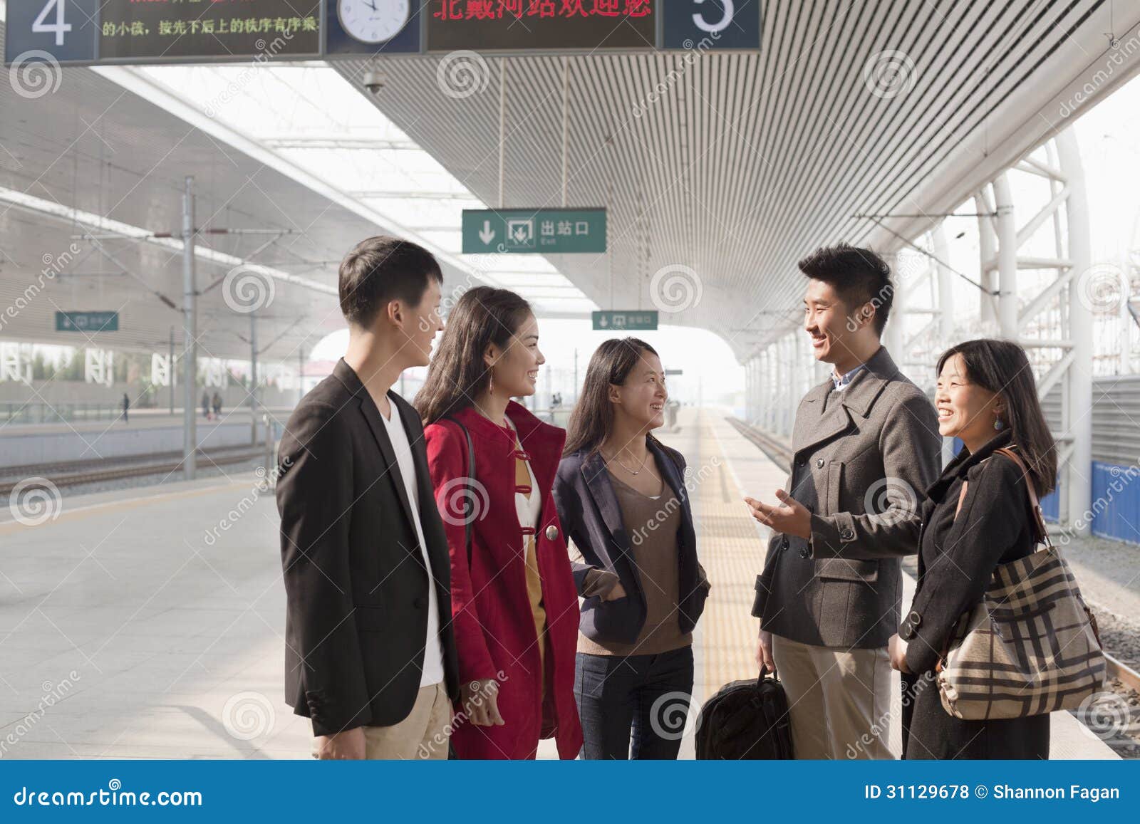 Group of Friends Smiling and Talking on Railway Platform Stock Photo ...