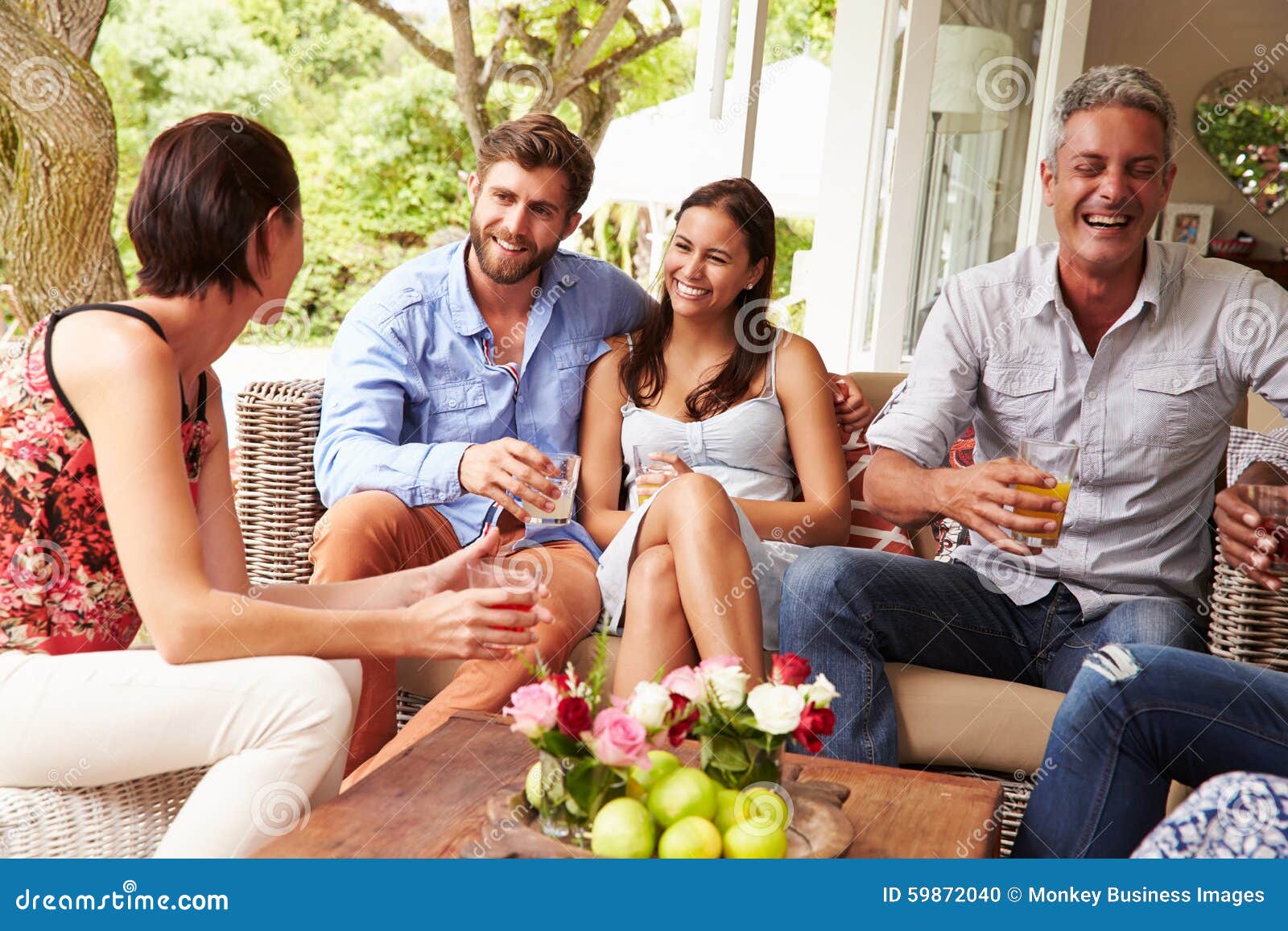 Group of Friends Socialising in a Conservatory Stock Photo - Image of ...